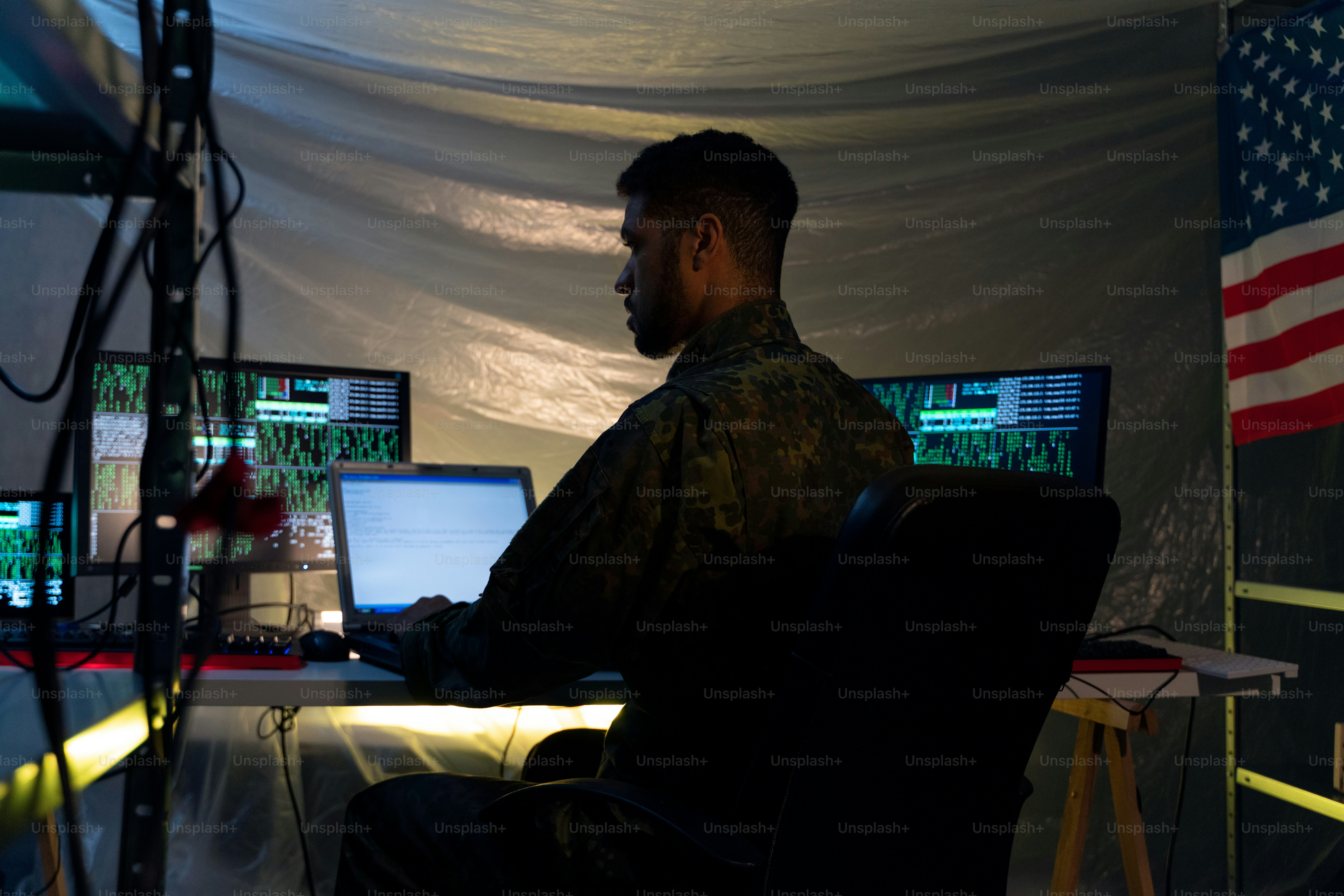 A hacker in military unifrorm on dark web, cyberwar concept. photo ...