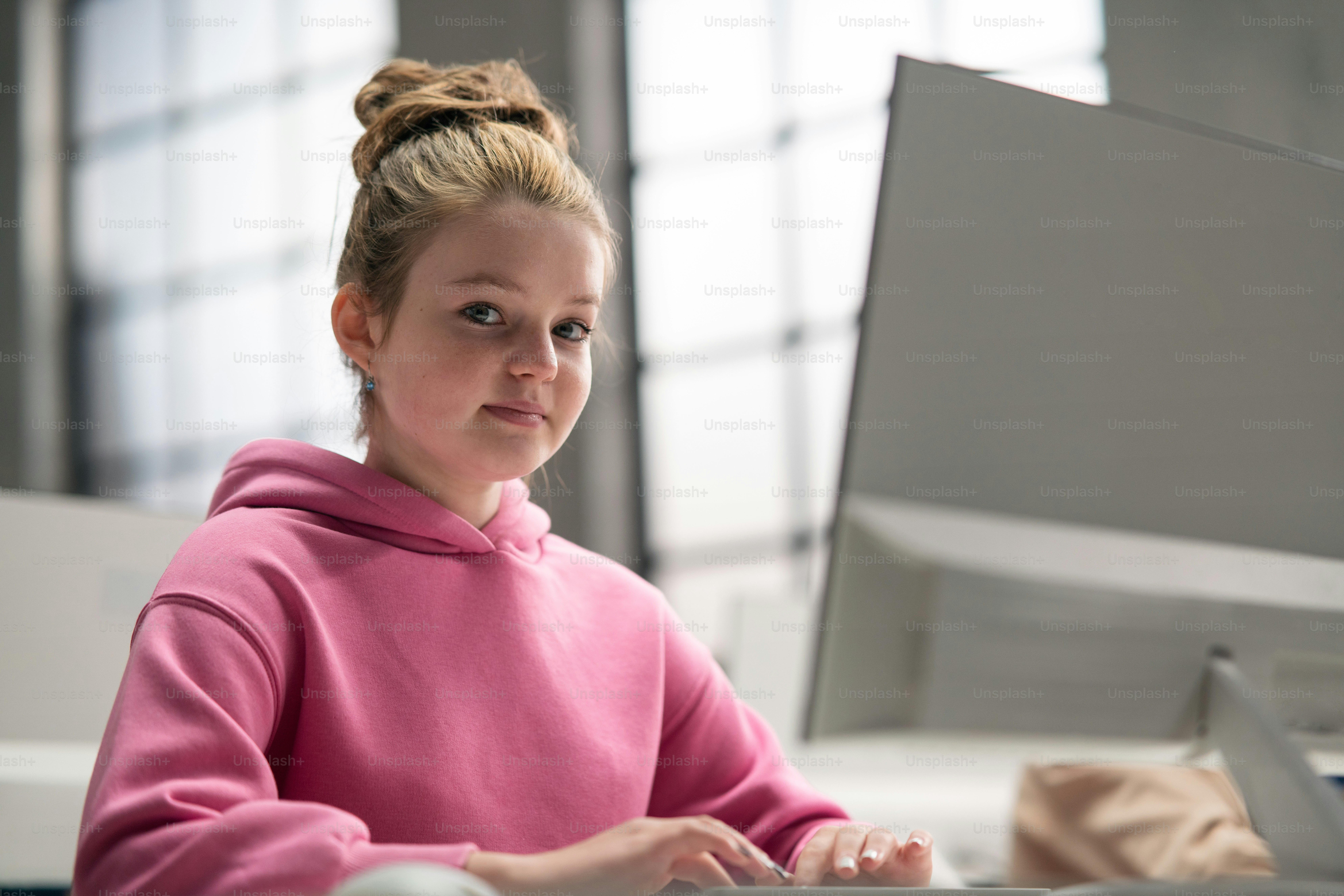 A schoolgirl using computer in classroom at school photo – Slovakia ...