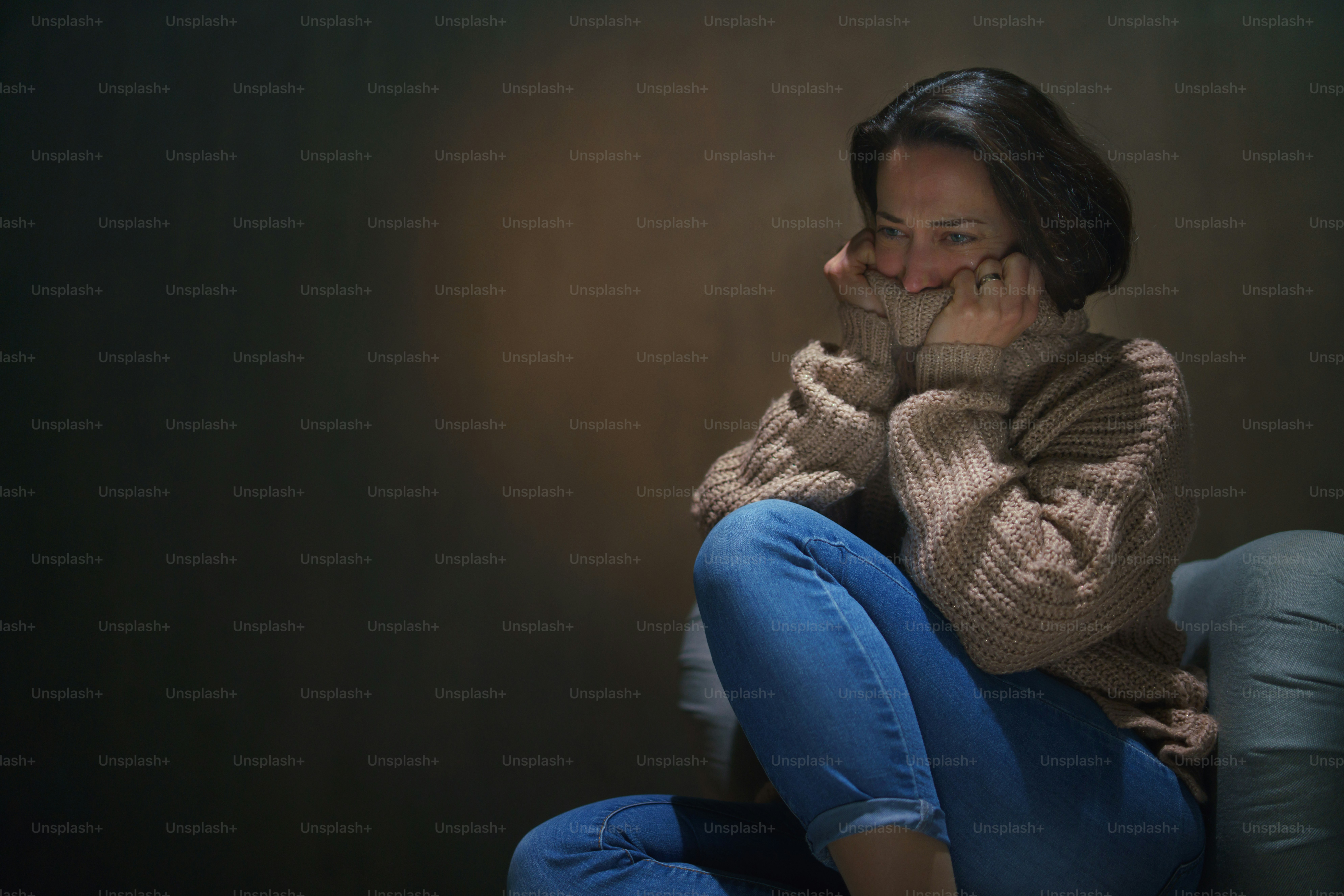 A depressed mid-adult lonely woman crying in the dark. photo – Despair ...
