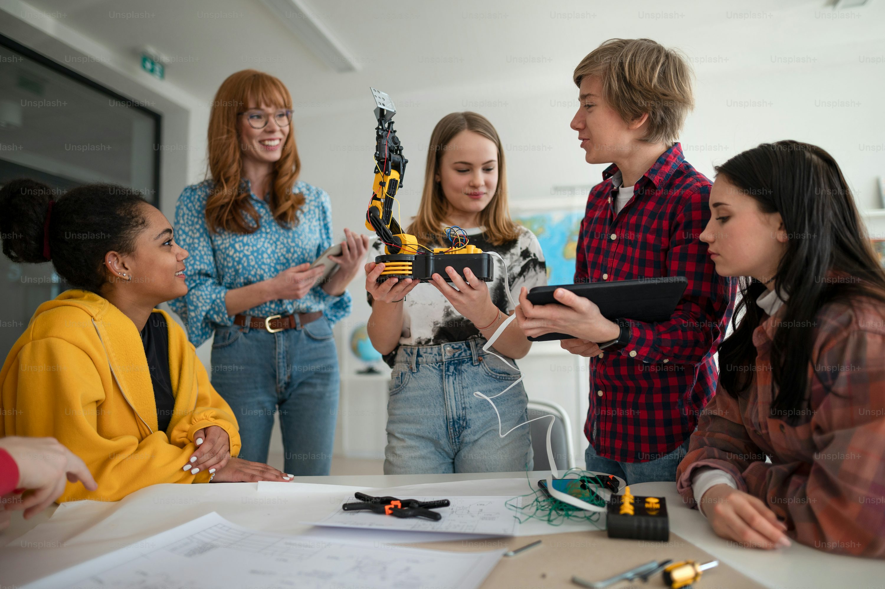 A group of students building and programming electric toys and robots ... A group of students building and programming electric toys and robots ...