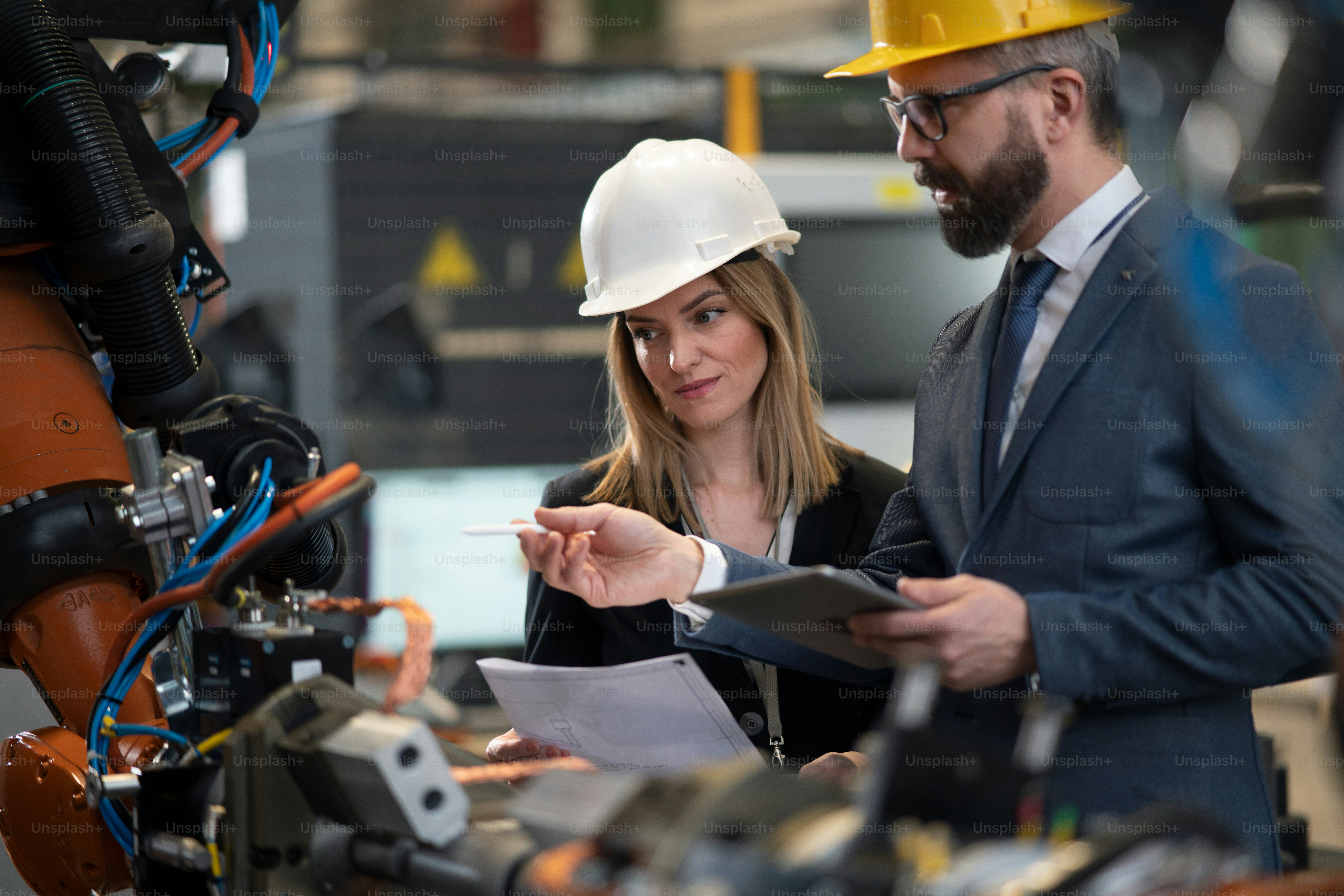 A chief engineer and project manager in modern industrial factory with ...