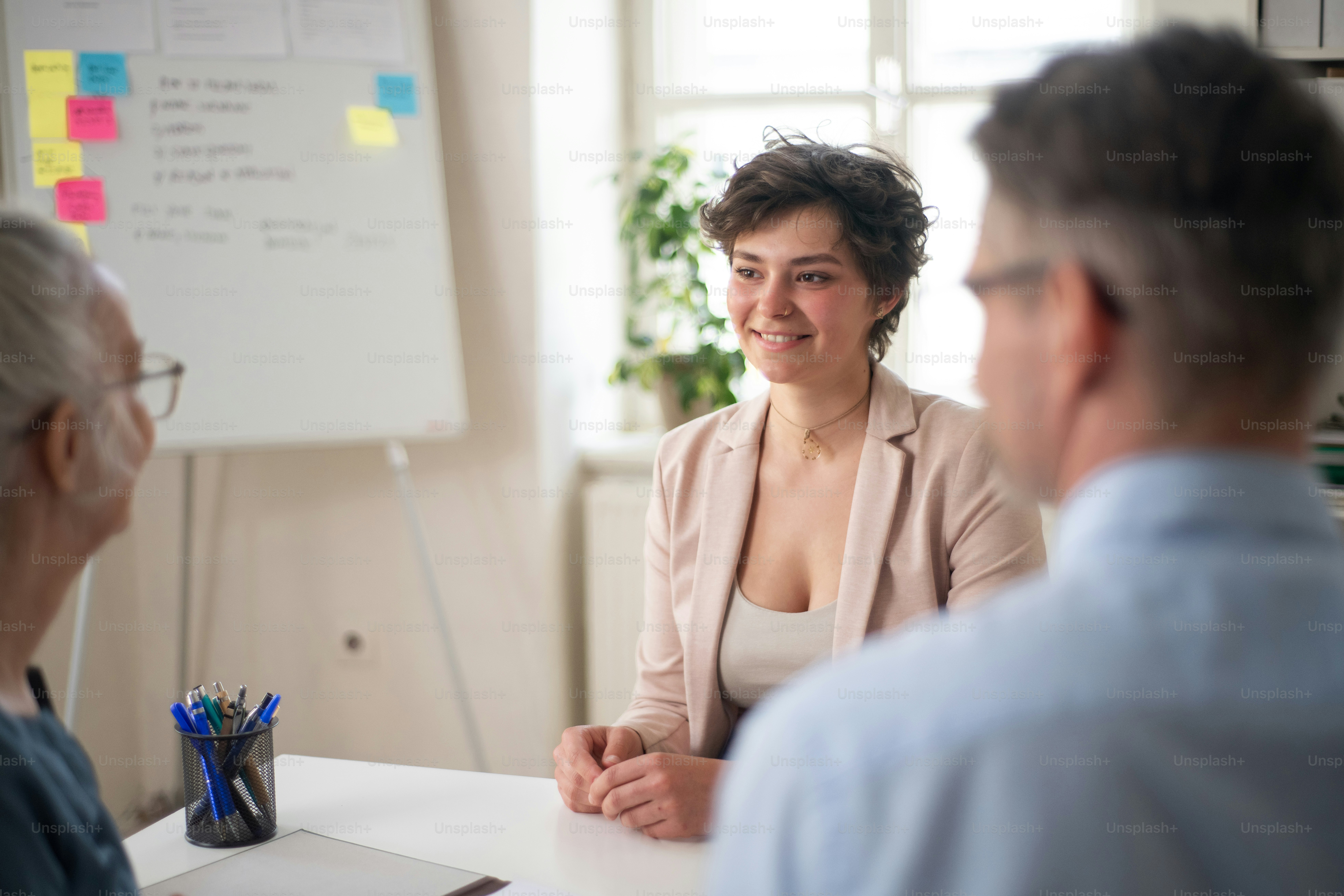 A young woman talking at a job interview. photo – Business Image on Unsplash