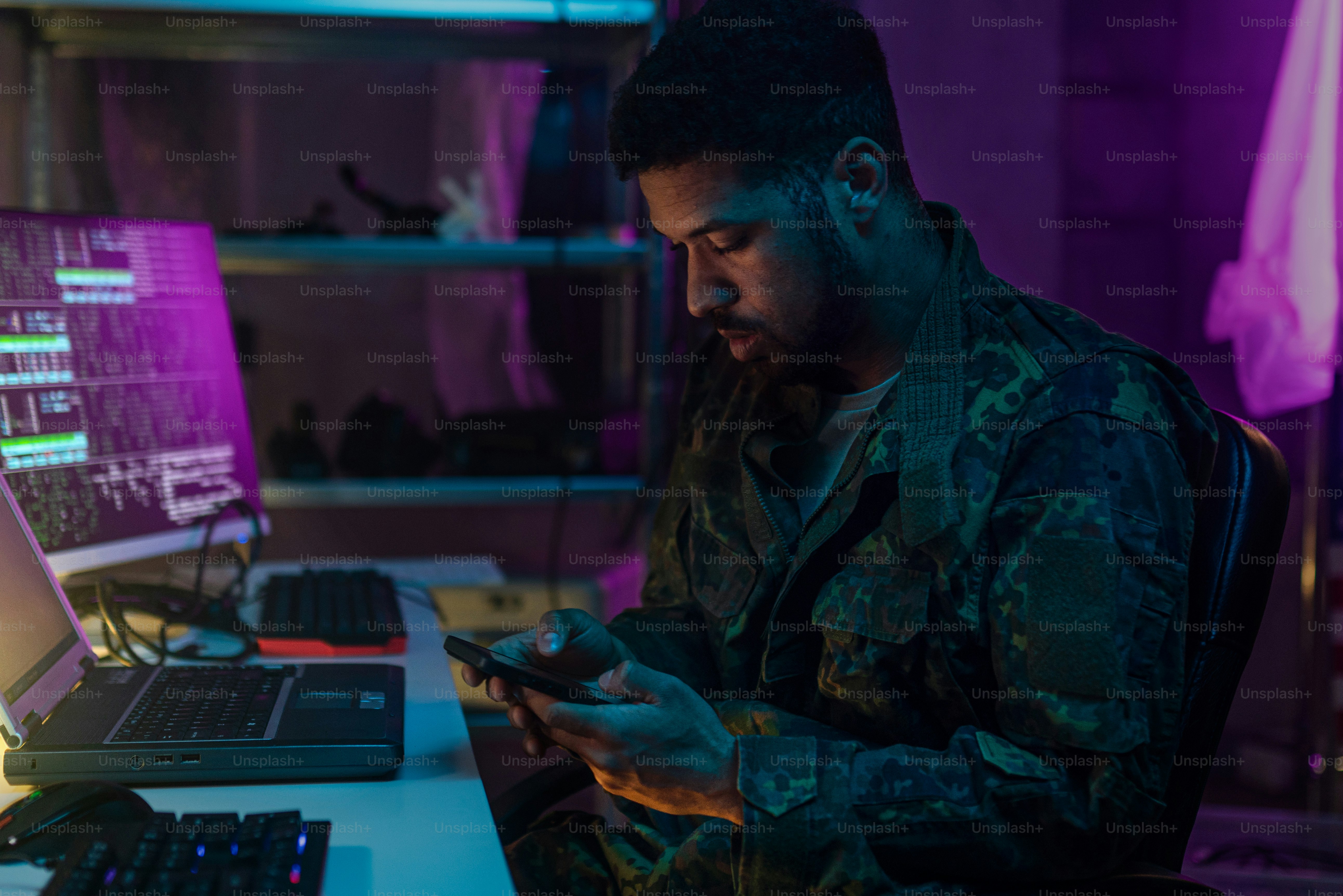 A hacker in military unifrorm on dark web, cyberwar concept. photo ...