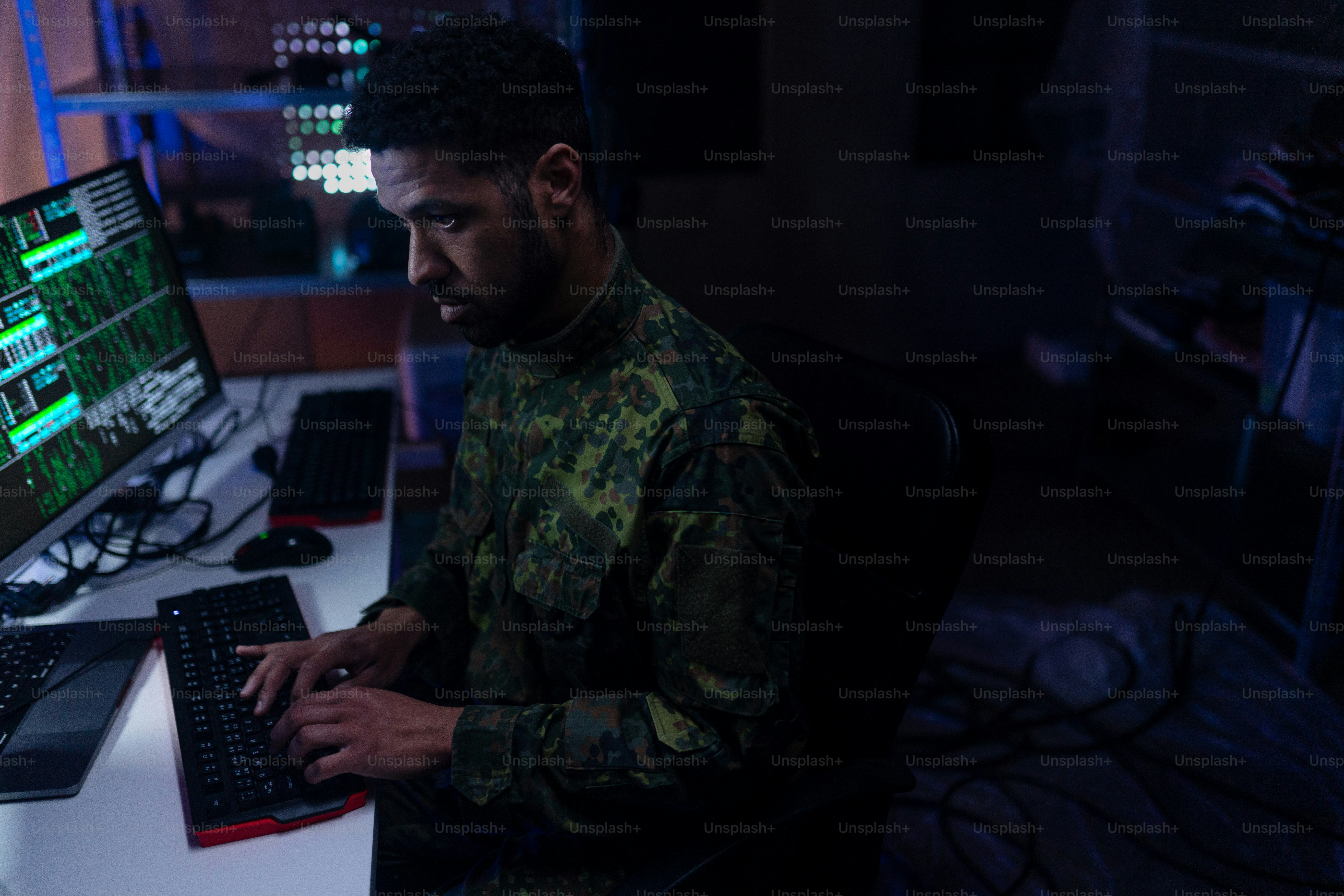 A hacker in military unifrorm on dark web, cyberwar concept. photo ...