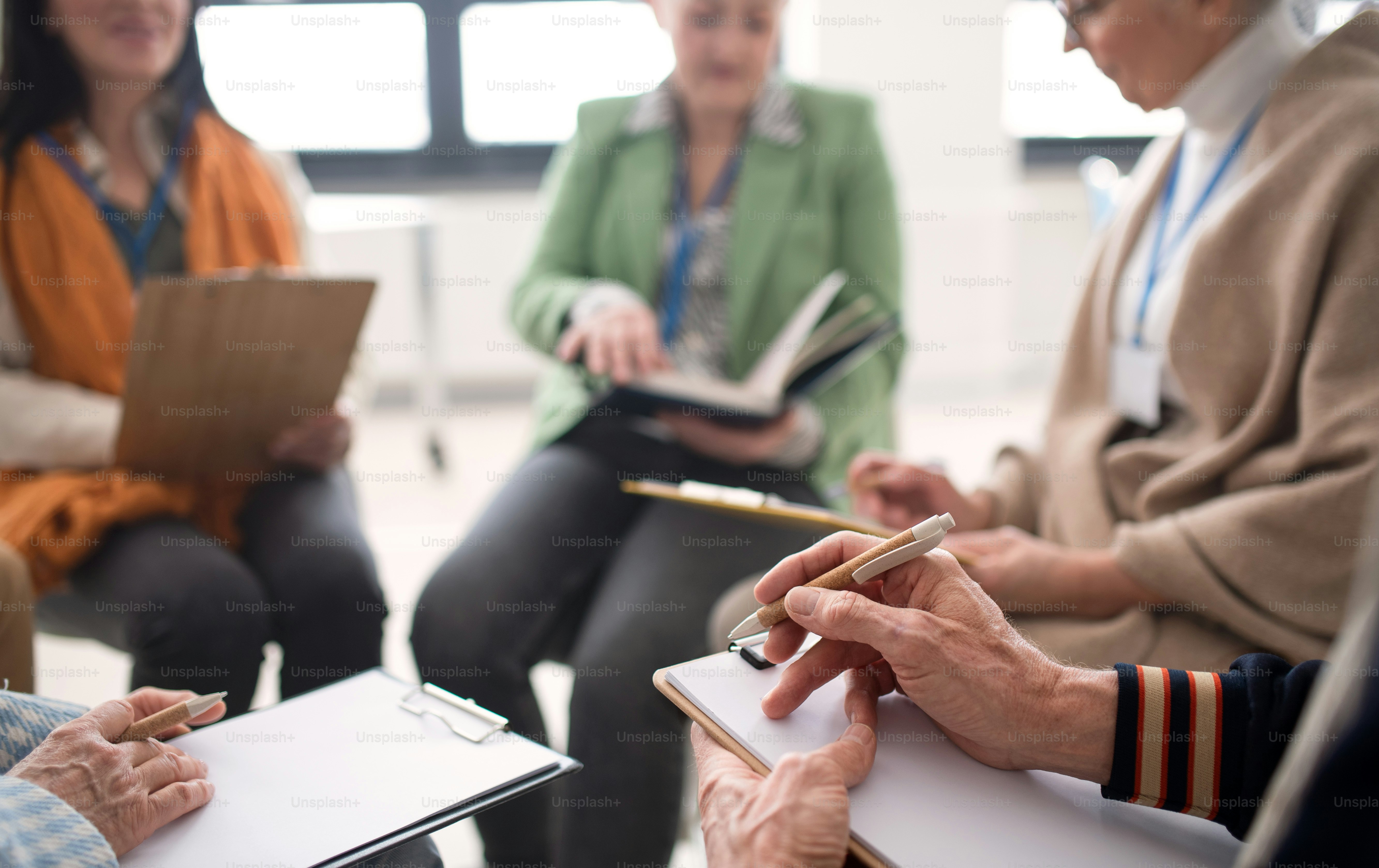 Excited elderly people attending a group therapy session at nursing ...