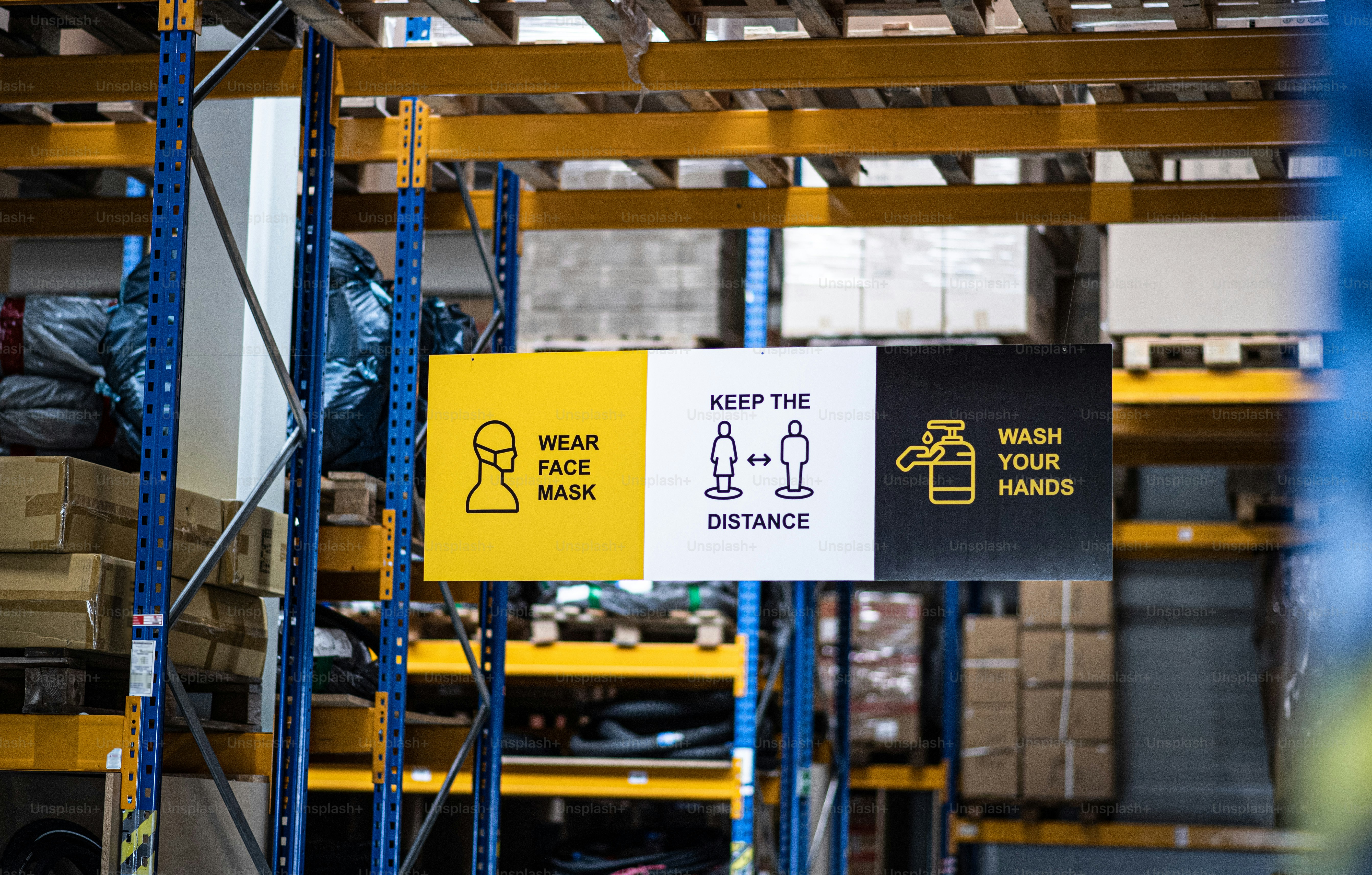 Safety signs on shelves indoors in a warehouse, coronavirus concept ...