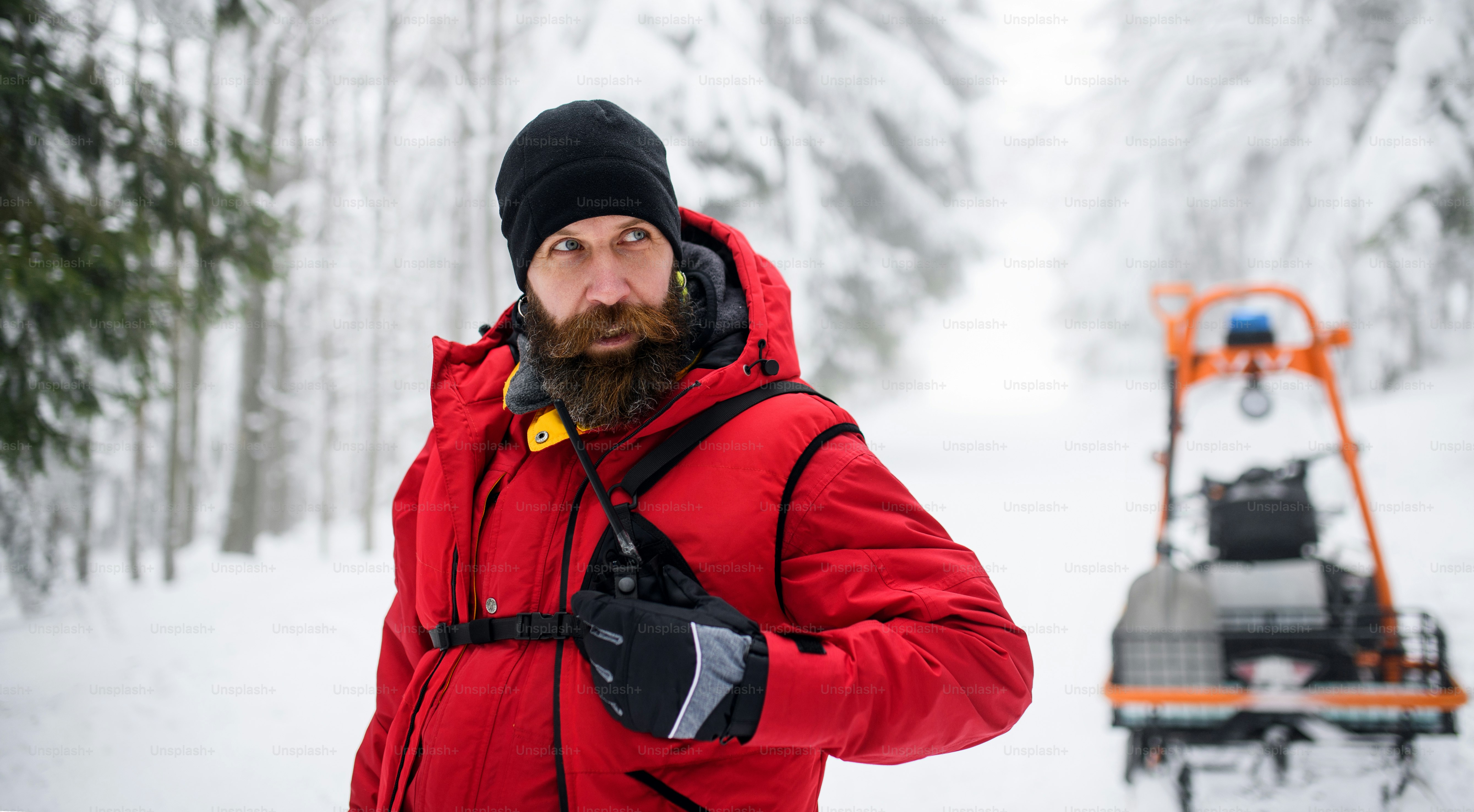 Paramedic man from mountain rescue service with walkie talkie outdoors ...