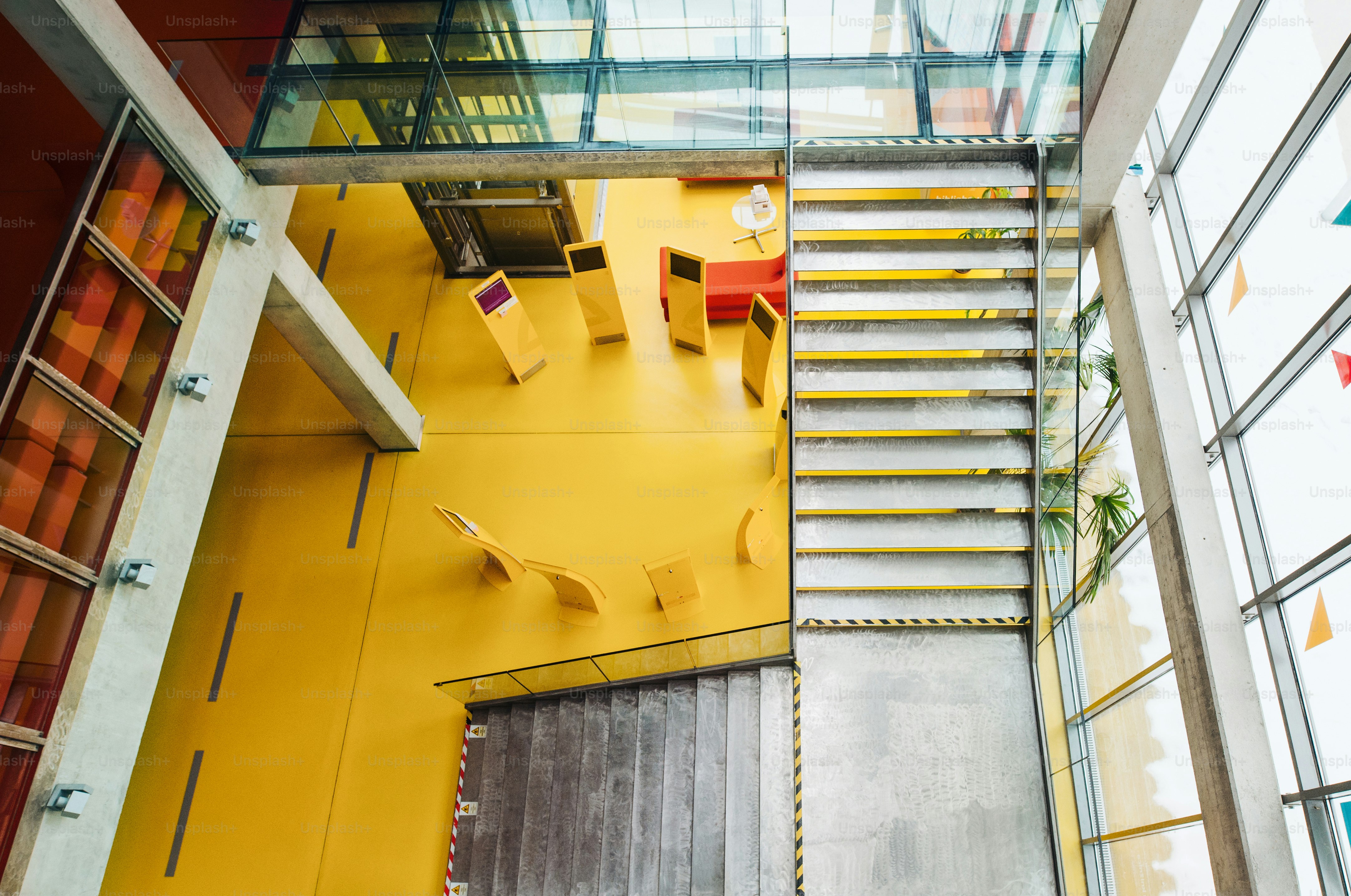 High-angle view of yellow interior of a modern spacious library with ...