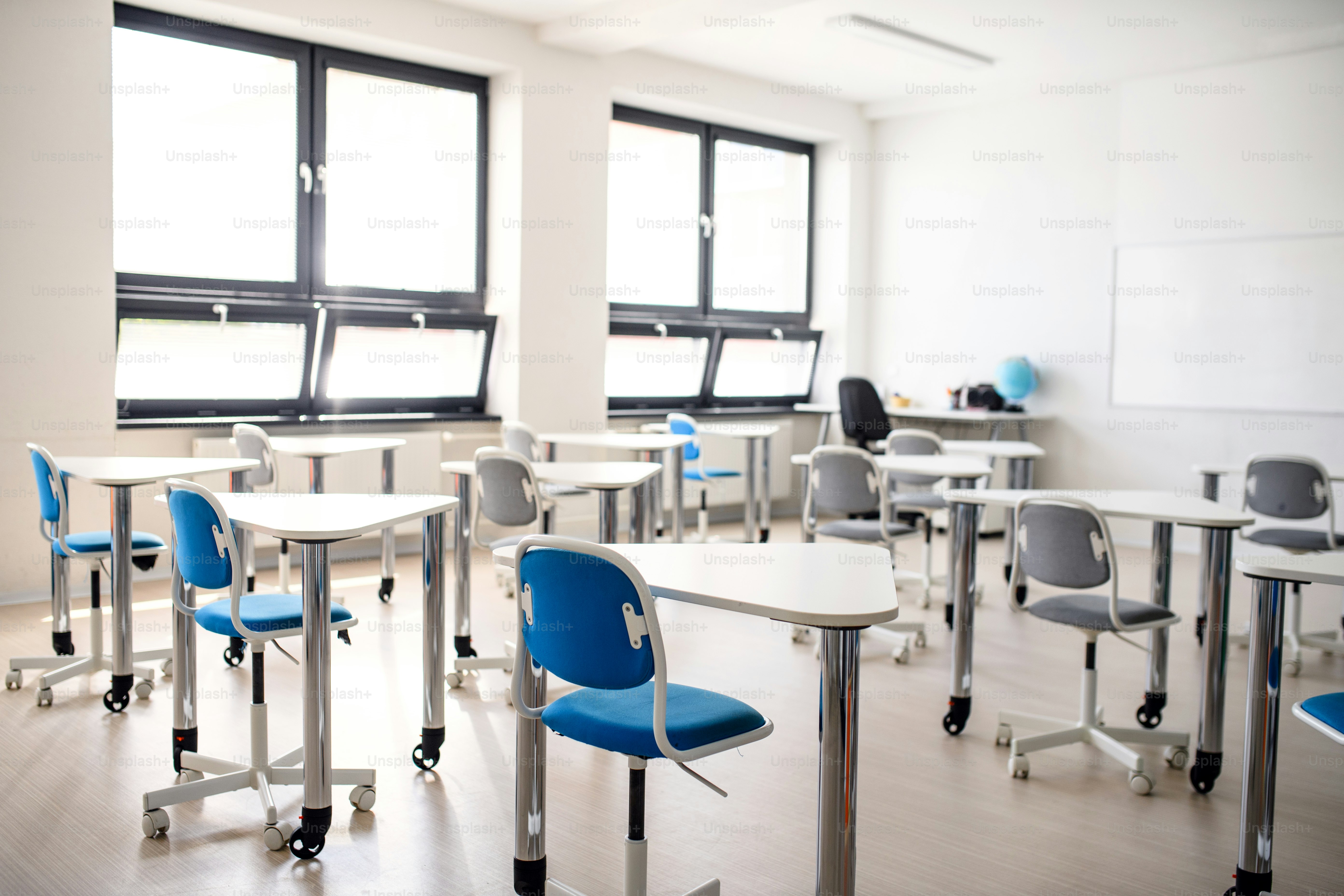 Desks in unconventional classoom, interior of private school. photo ...
