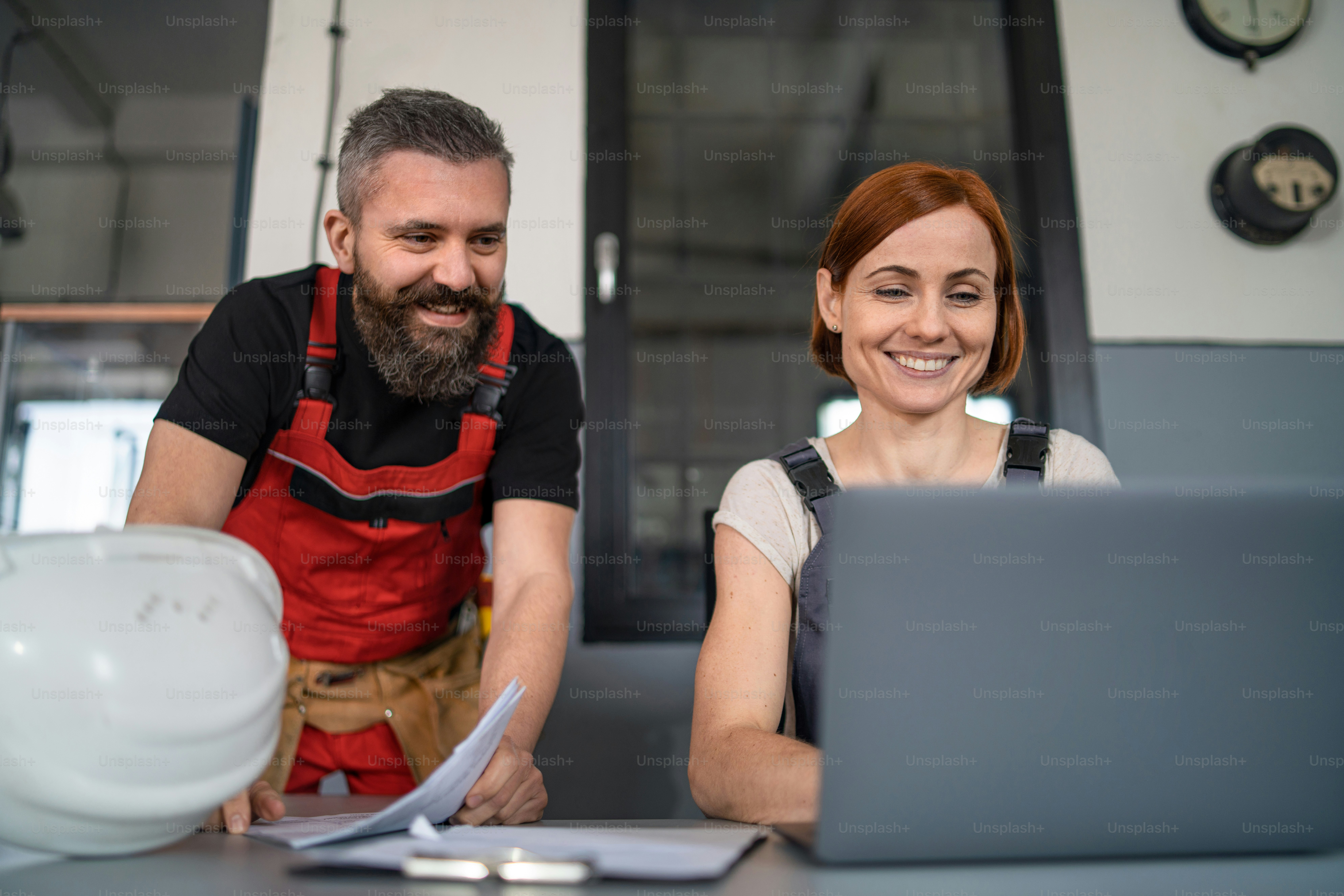 Group of workers or industry engineers with laptop indoors in factory ...