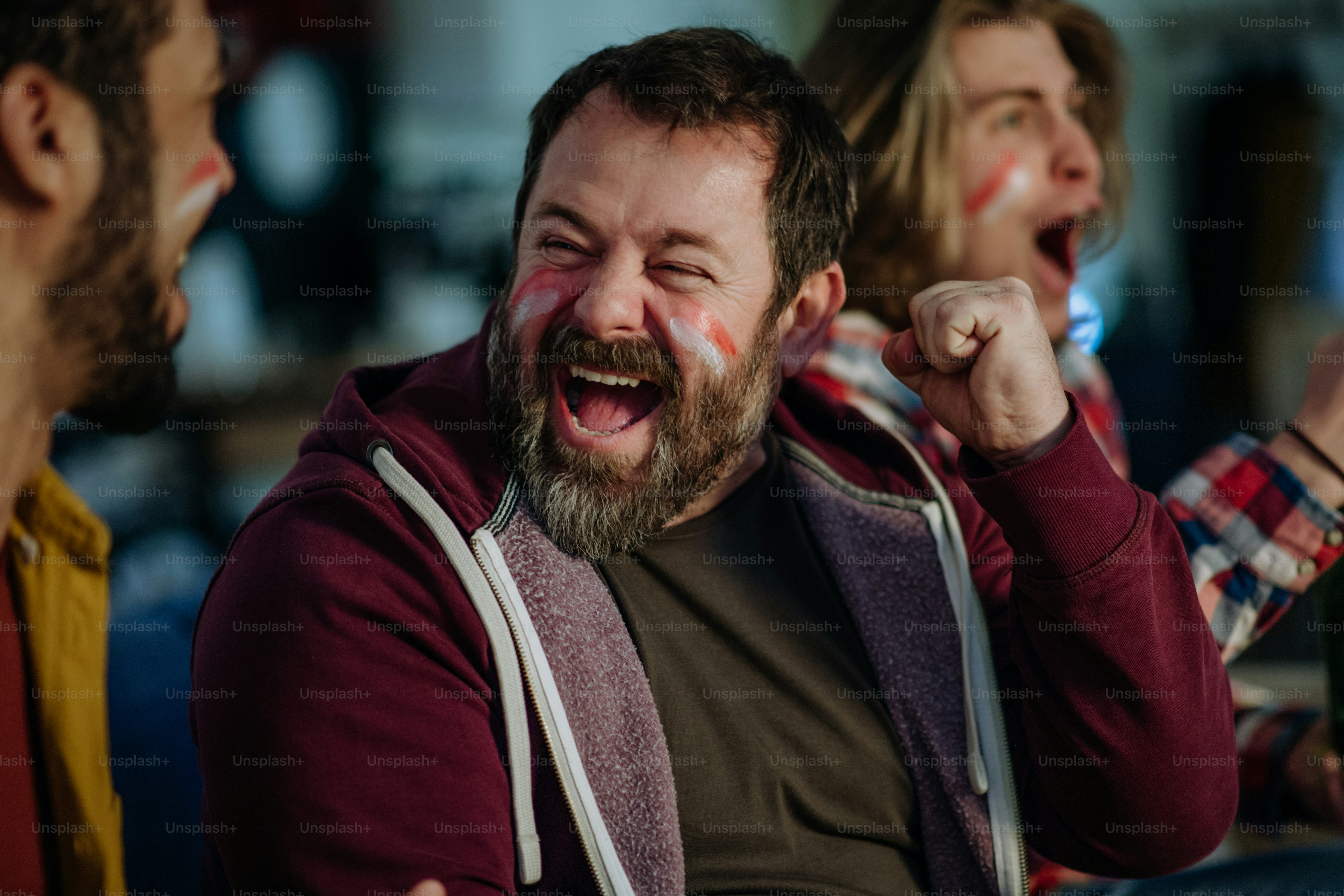 Happy Austrian football fans friends watching football at home and ...