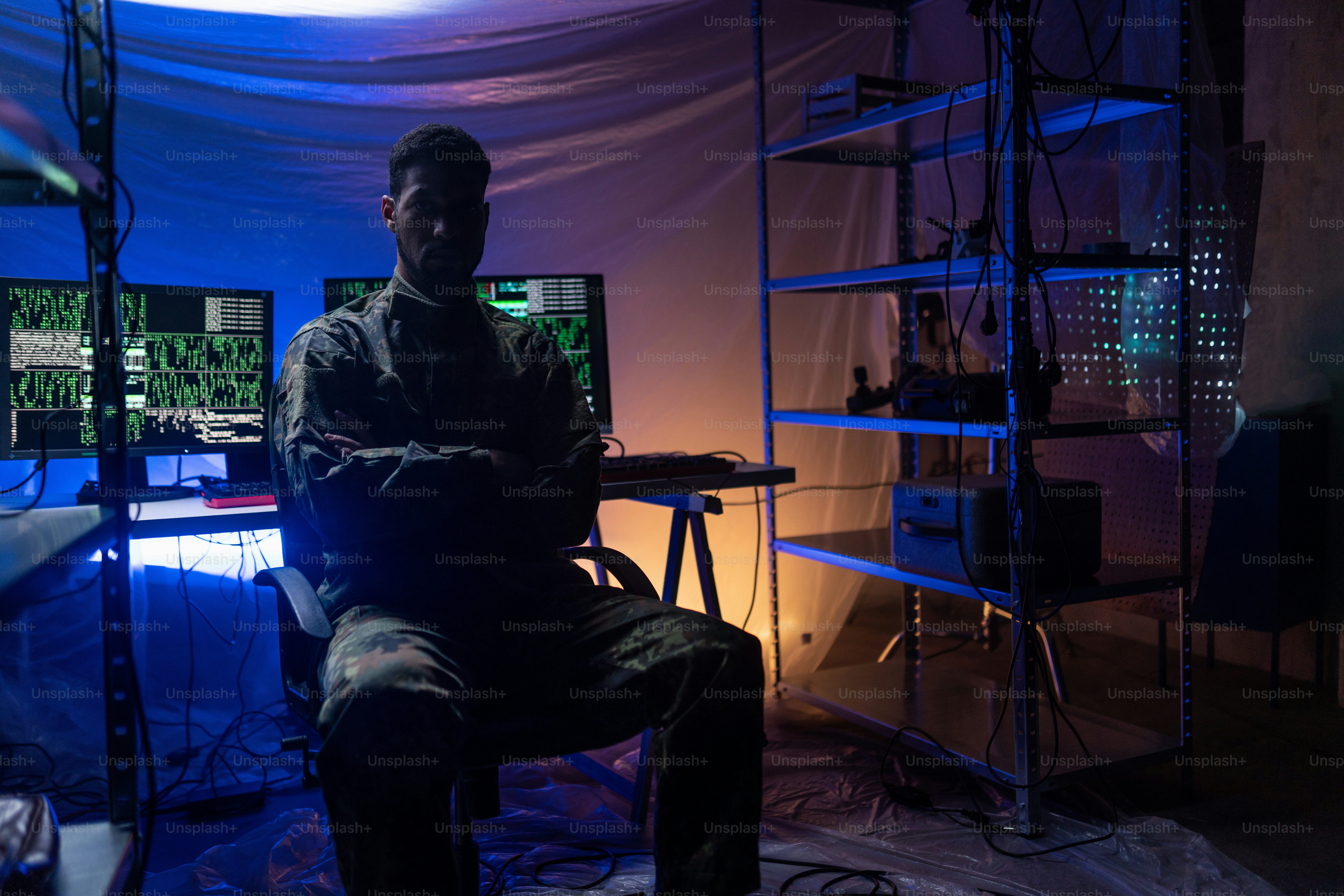 An anonymous hacker in military unifrorm on dark web, cyberwar concept ...