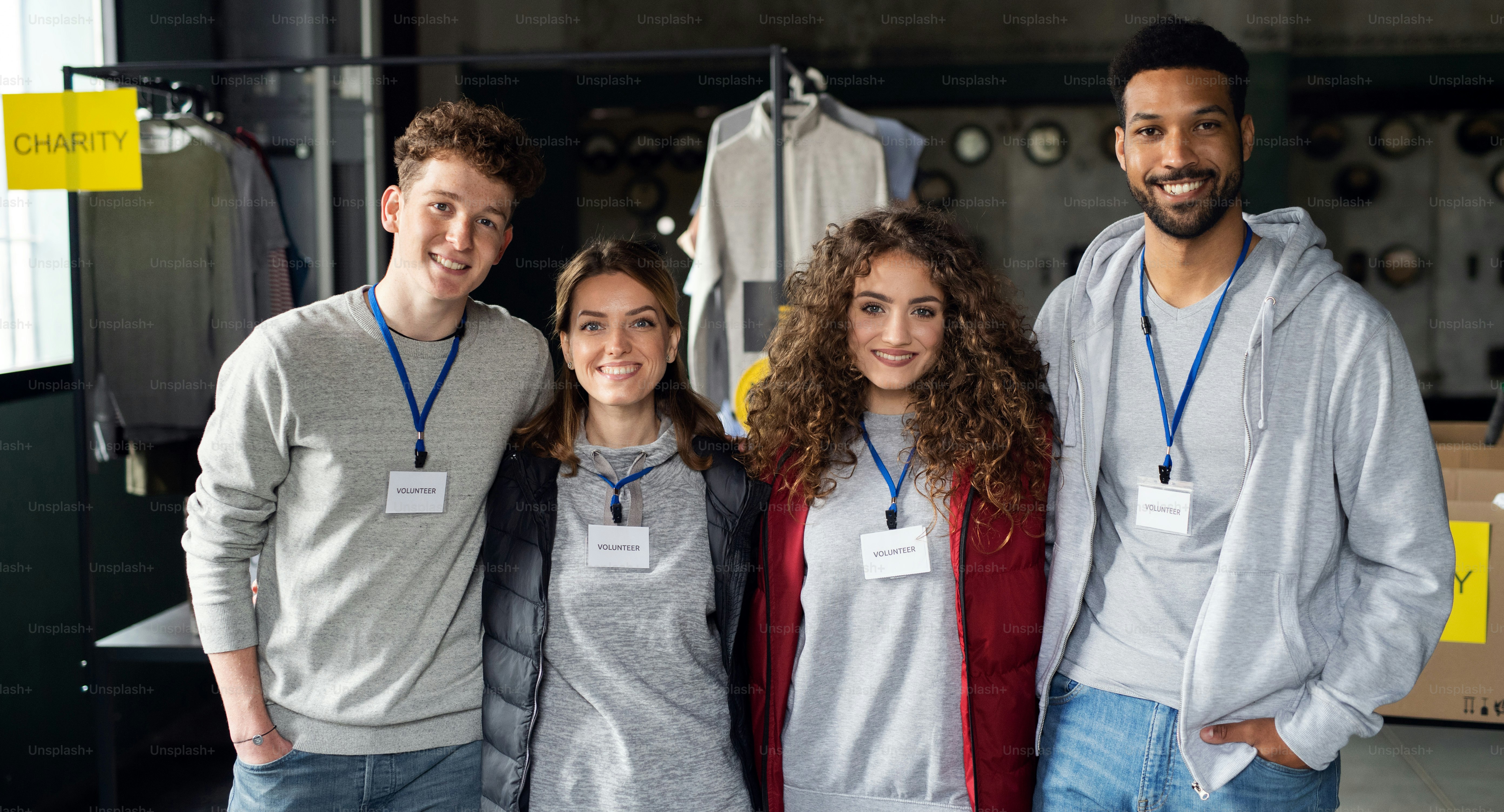 A group of volunteers working in community charity donation center ...