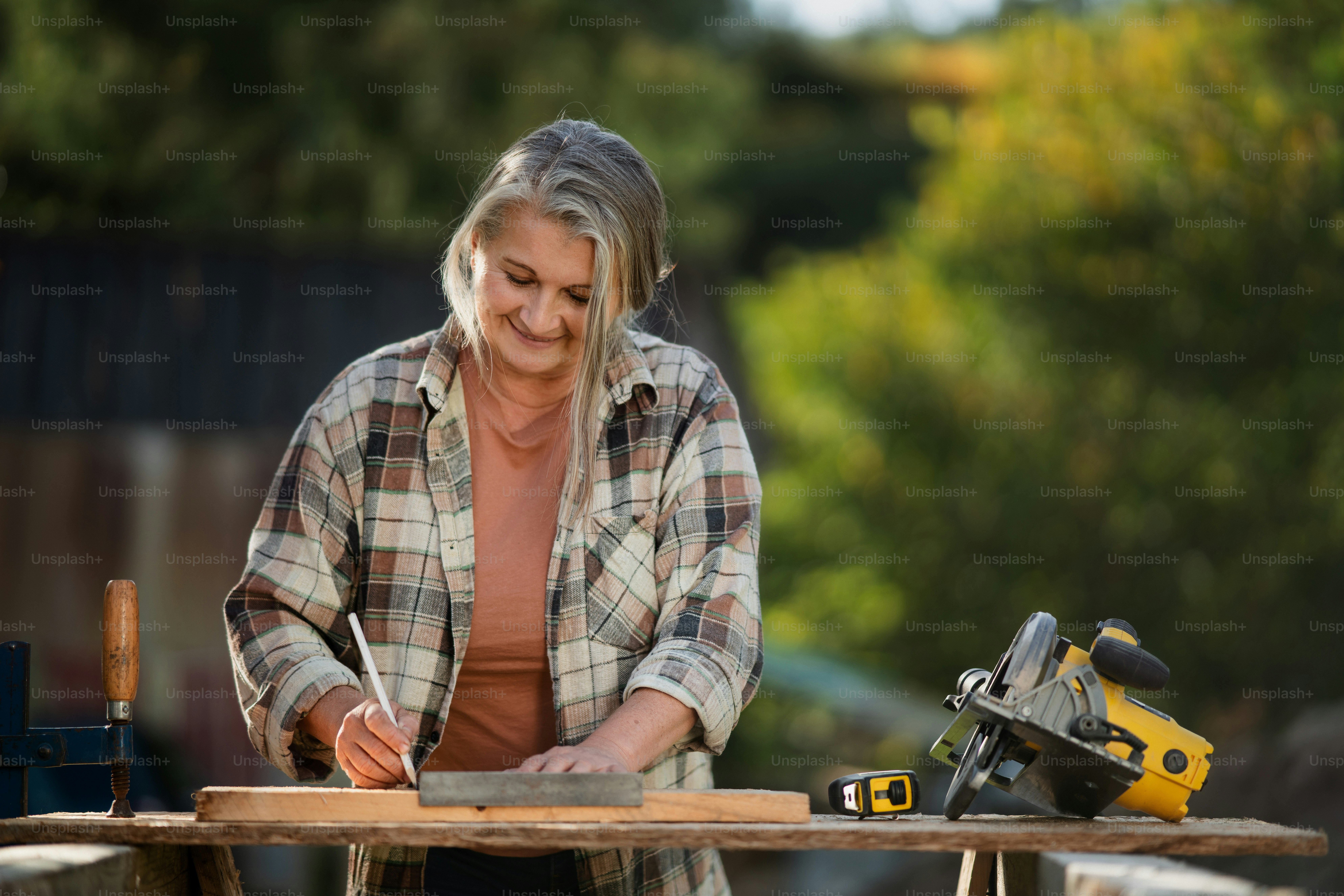A handy female carpenter working in carpentry diy workshop outdoors photo – Slovakia Image on ...