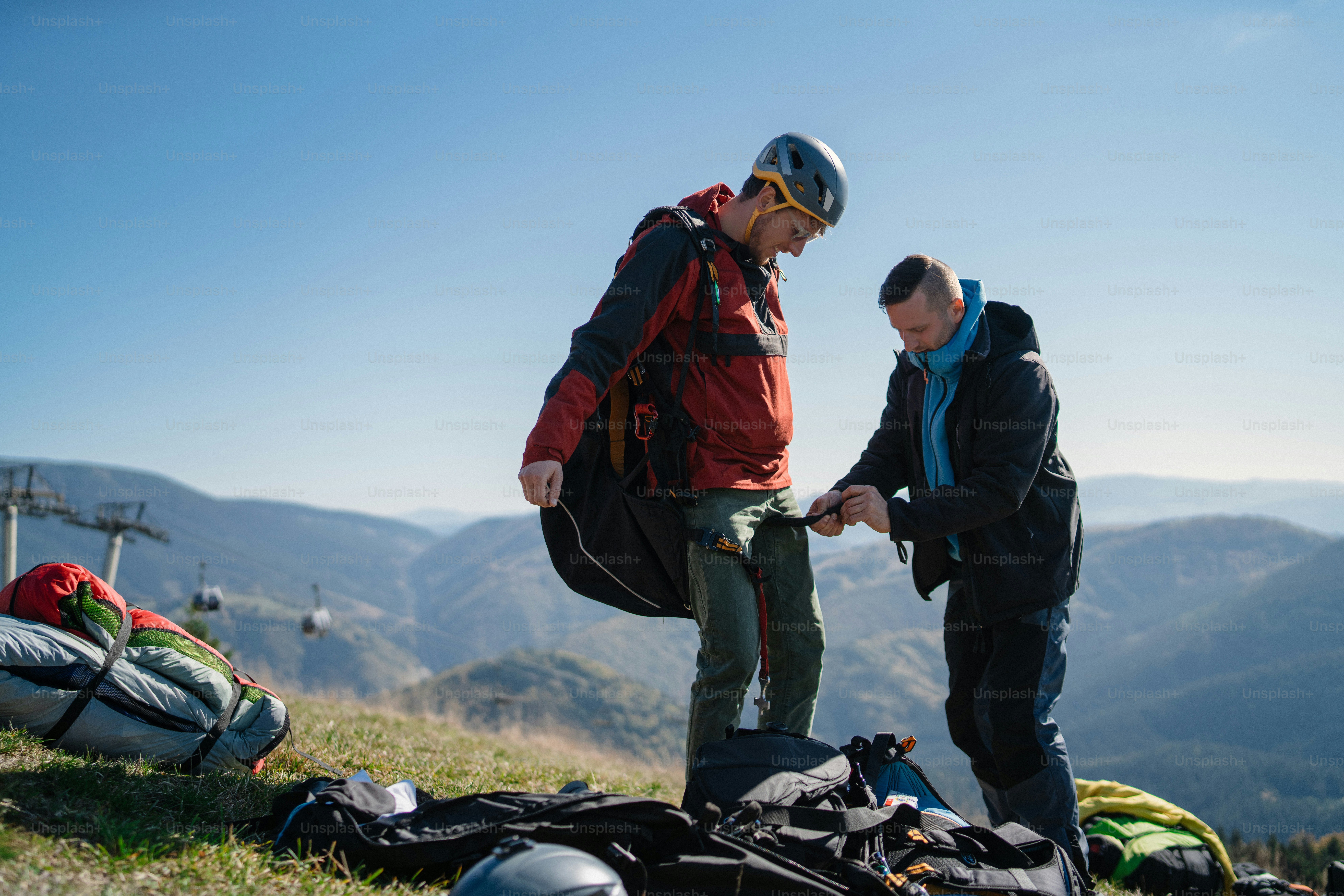 A man helping paragliding pilot to prepare for flight. photo – People ...