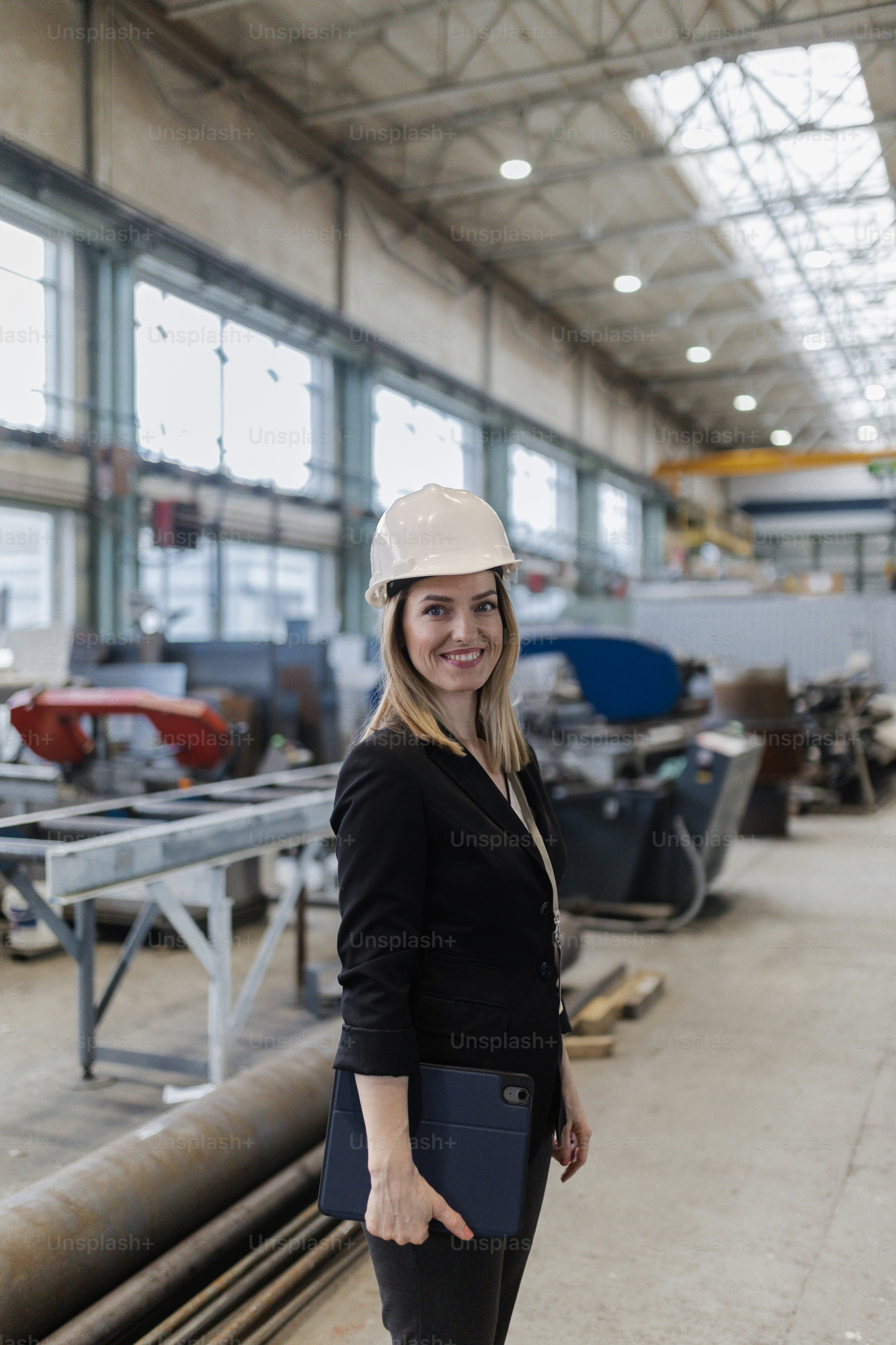 A portrait of female chief engineer in modern industrial factory ...