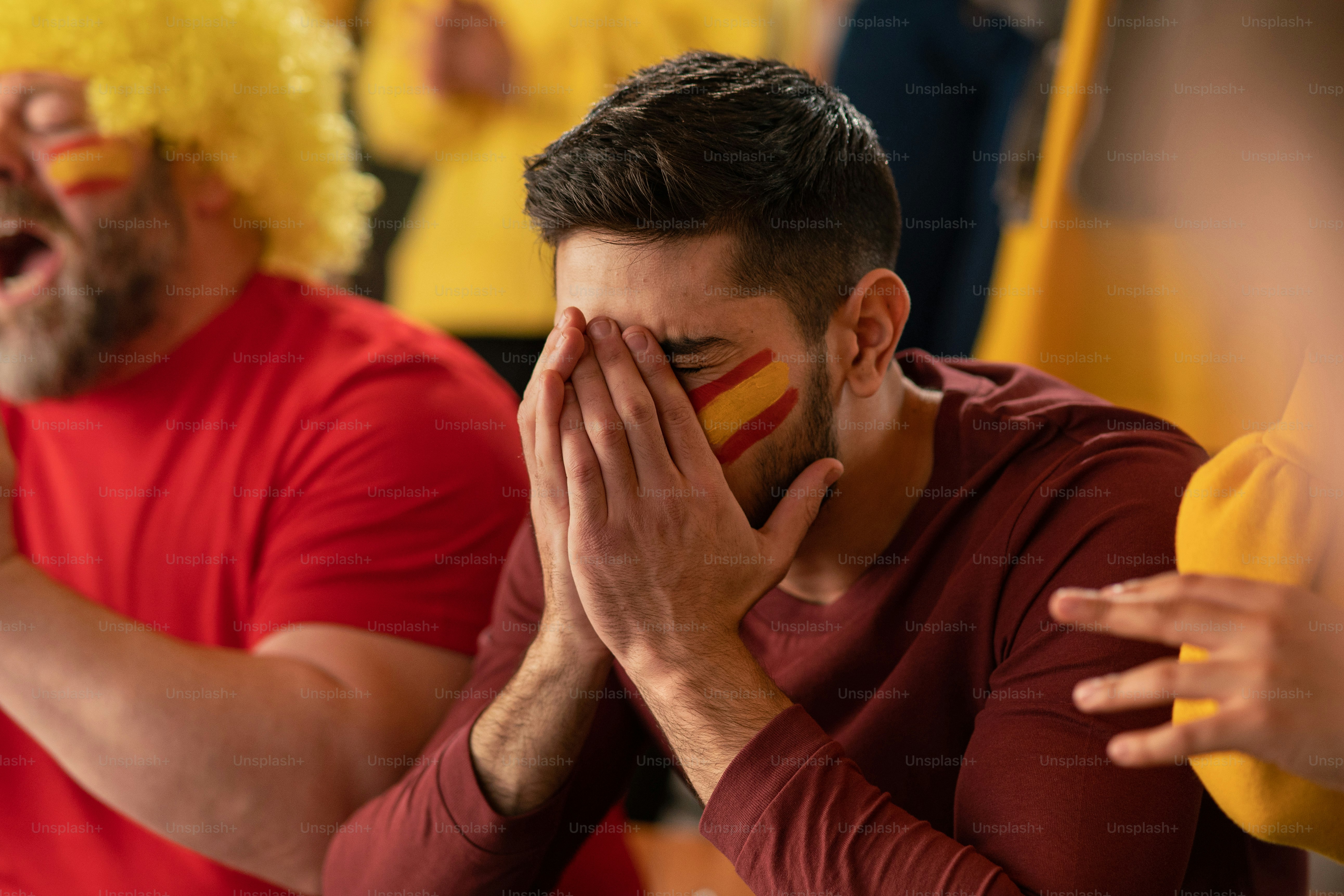 Worried football fans supproting a spanish national team in live soccer ...