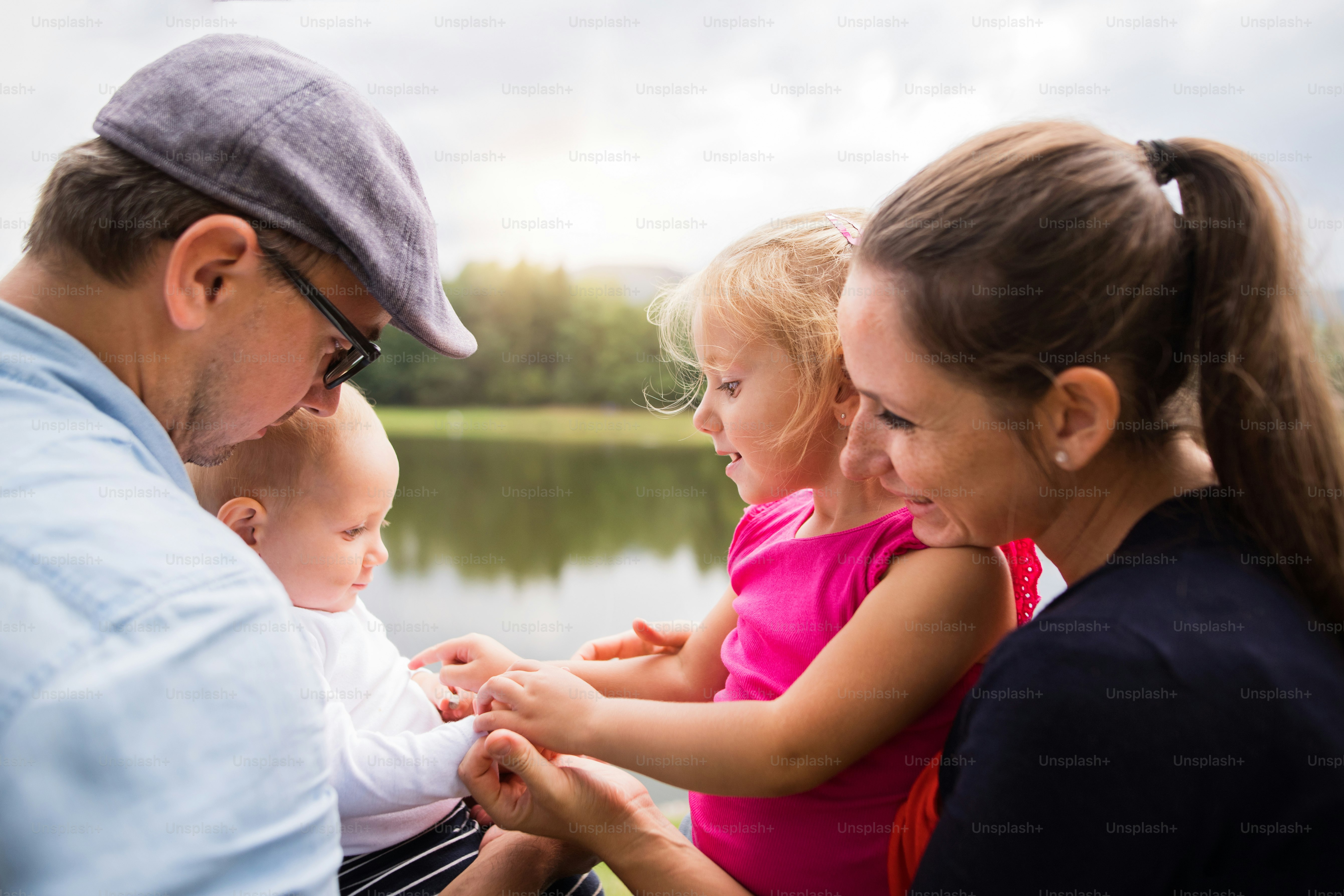 Happy young family spending time together outside in green nature by ...