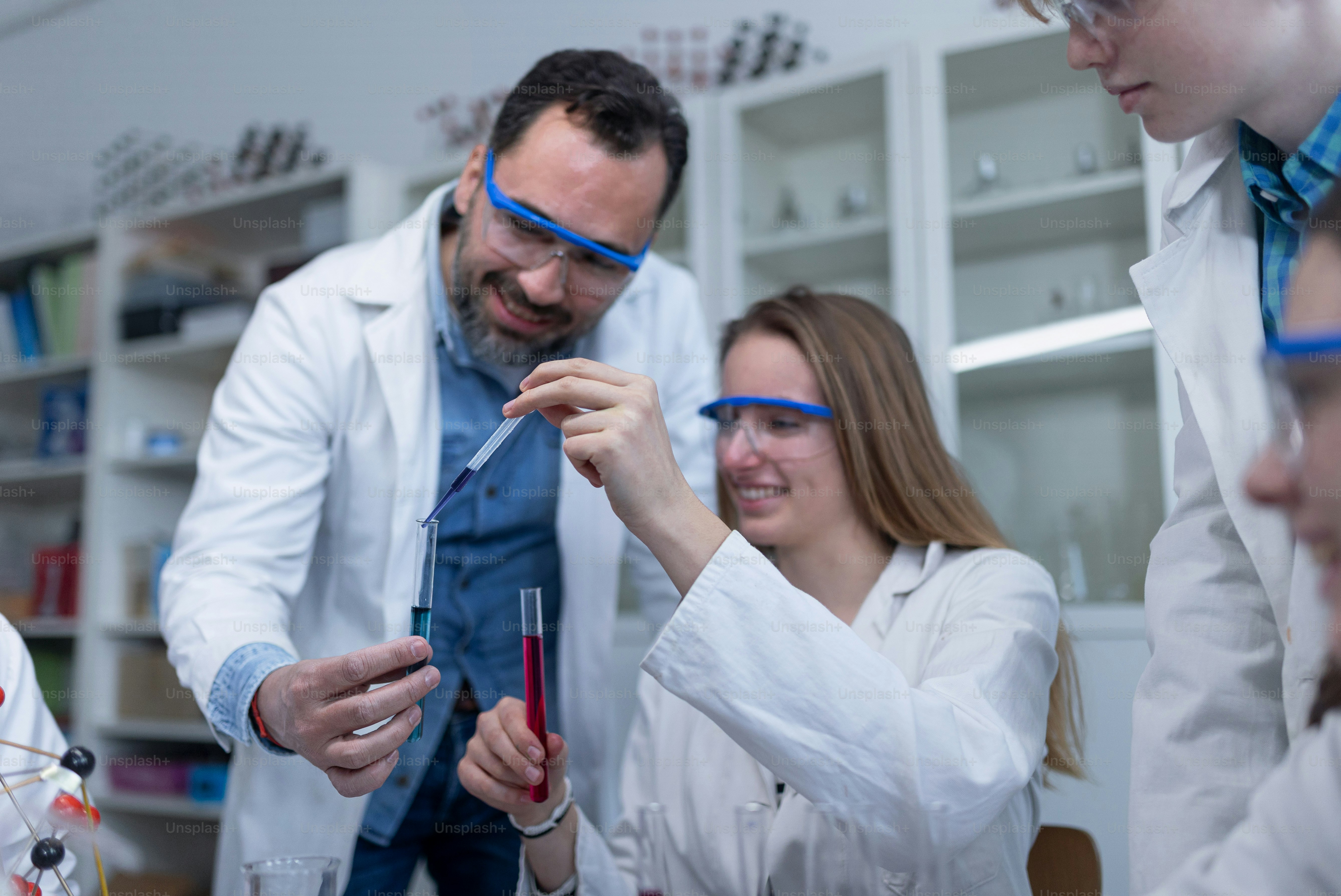 Science students doing a chemical experiment in the laboratory at ...