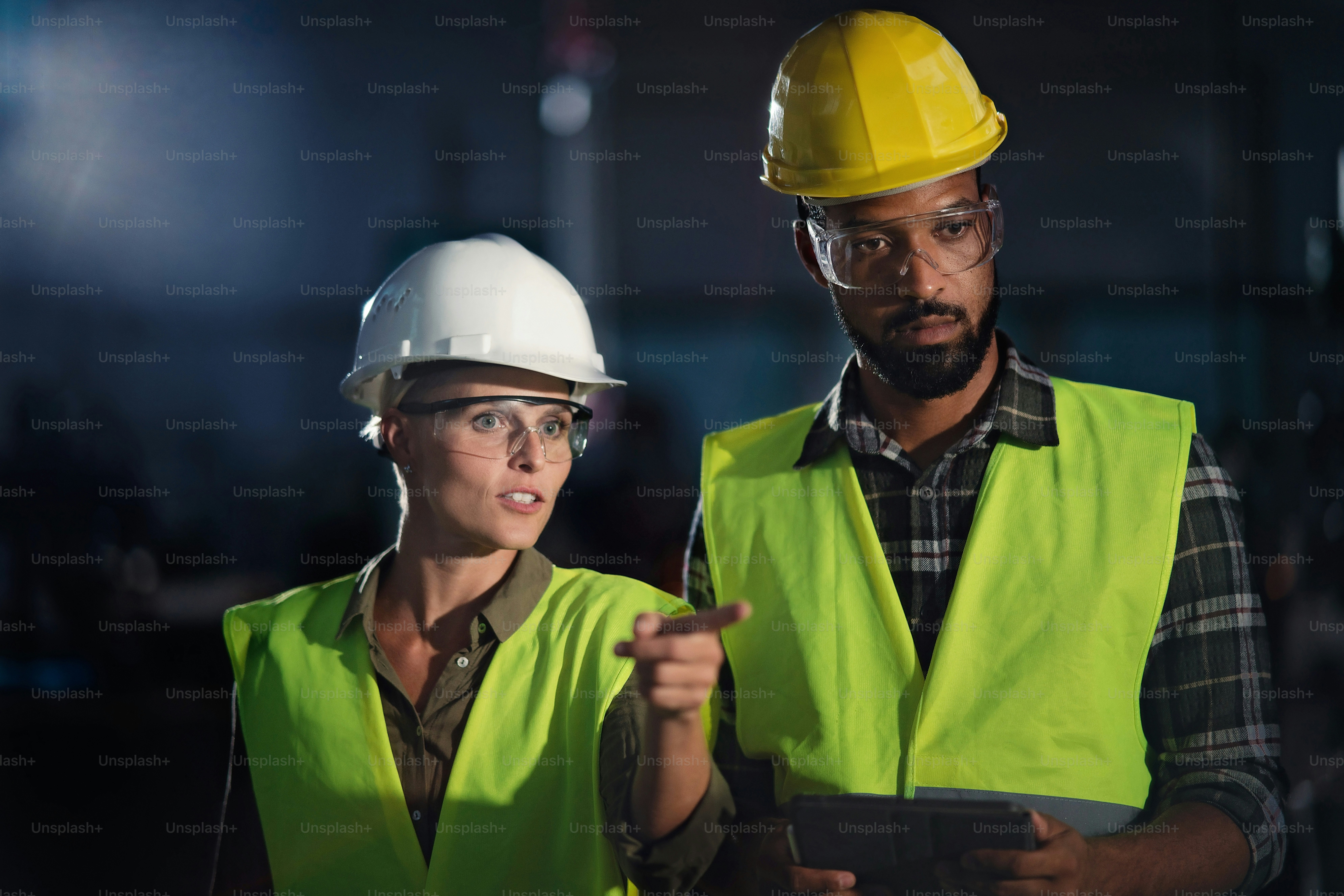 A portrait of industrial inspectors doing a general check up indoors at ...