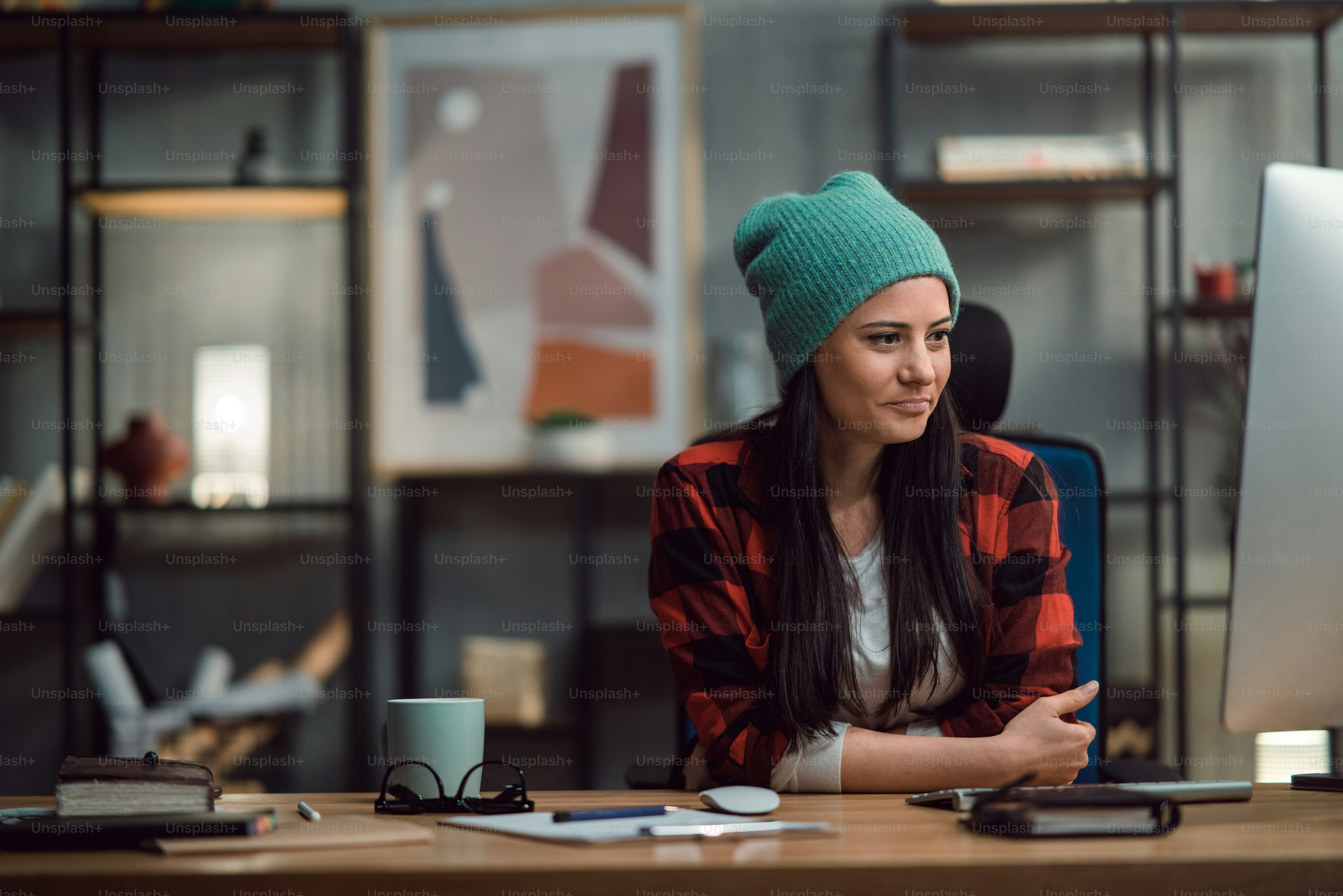A female video editor works indoors in creative office studio. photo ...