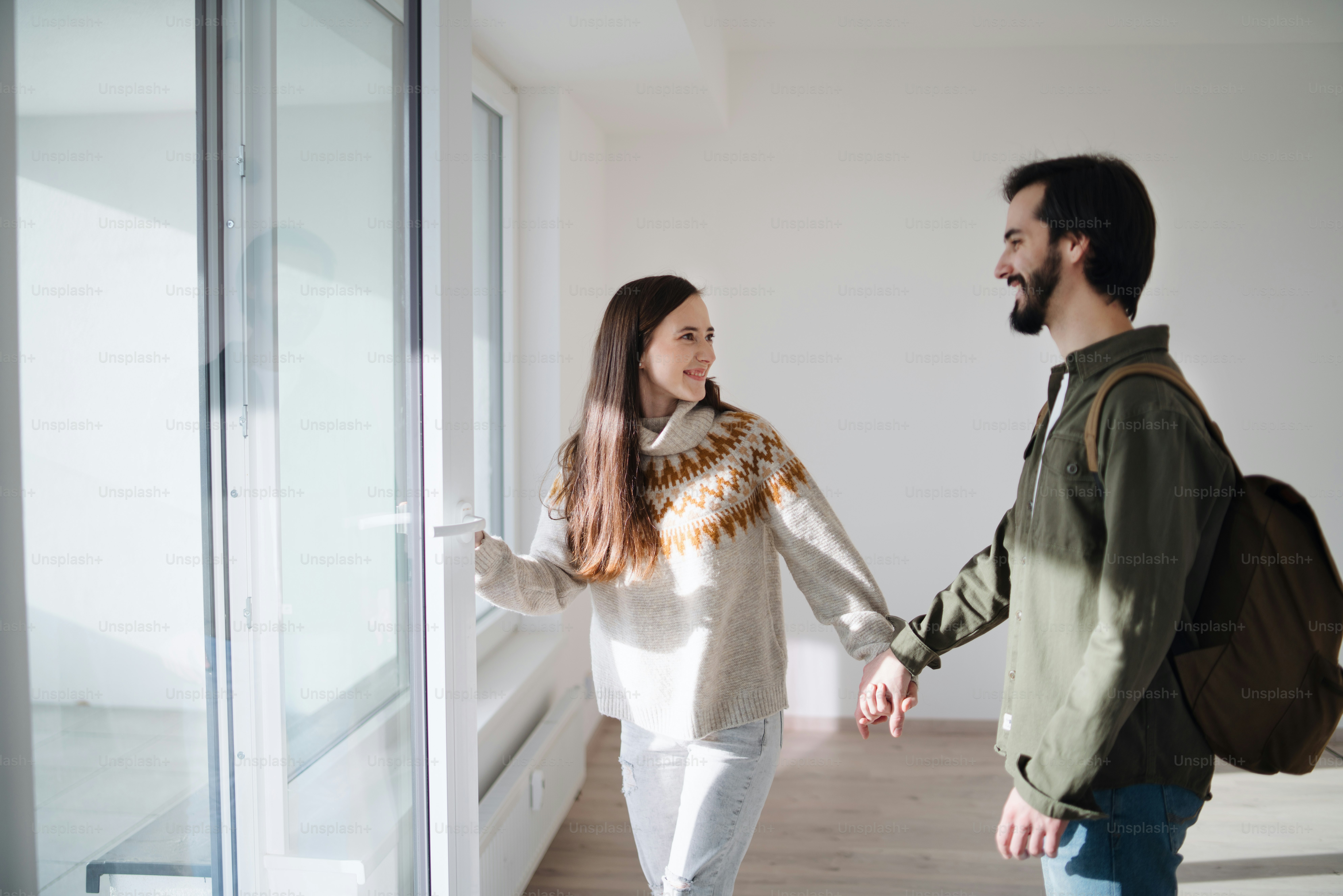 Happy young couple moving in new flat, new home and relocation concept. photo – Husband and wife ...