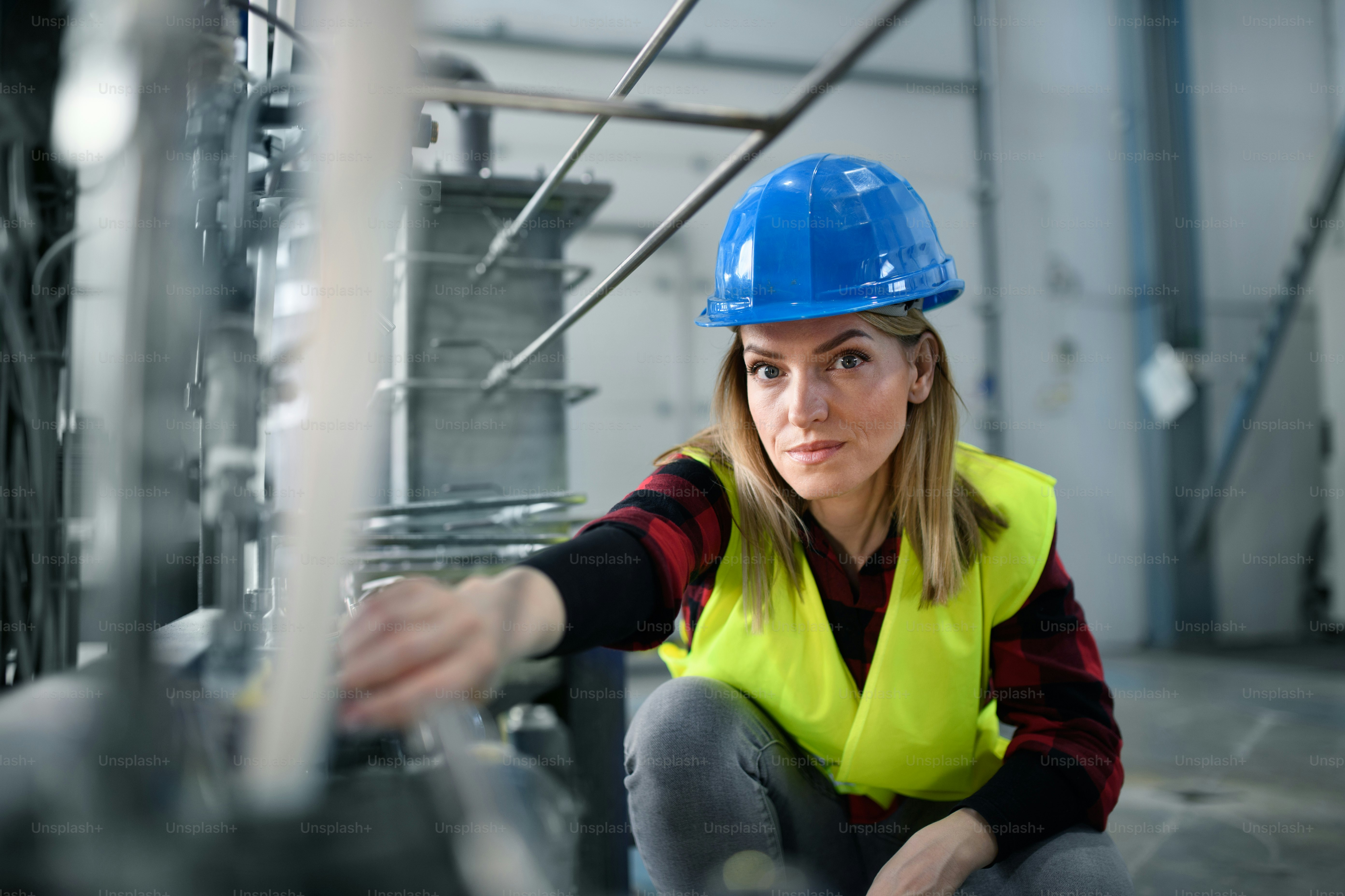A portrait of female engineer working in industrial factory photo ...