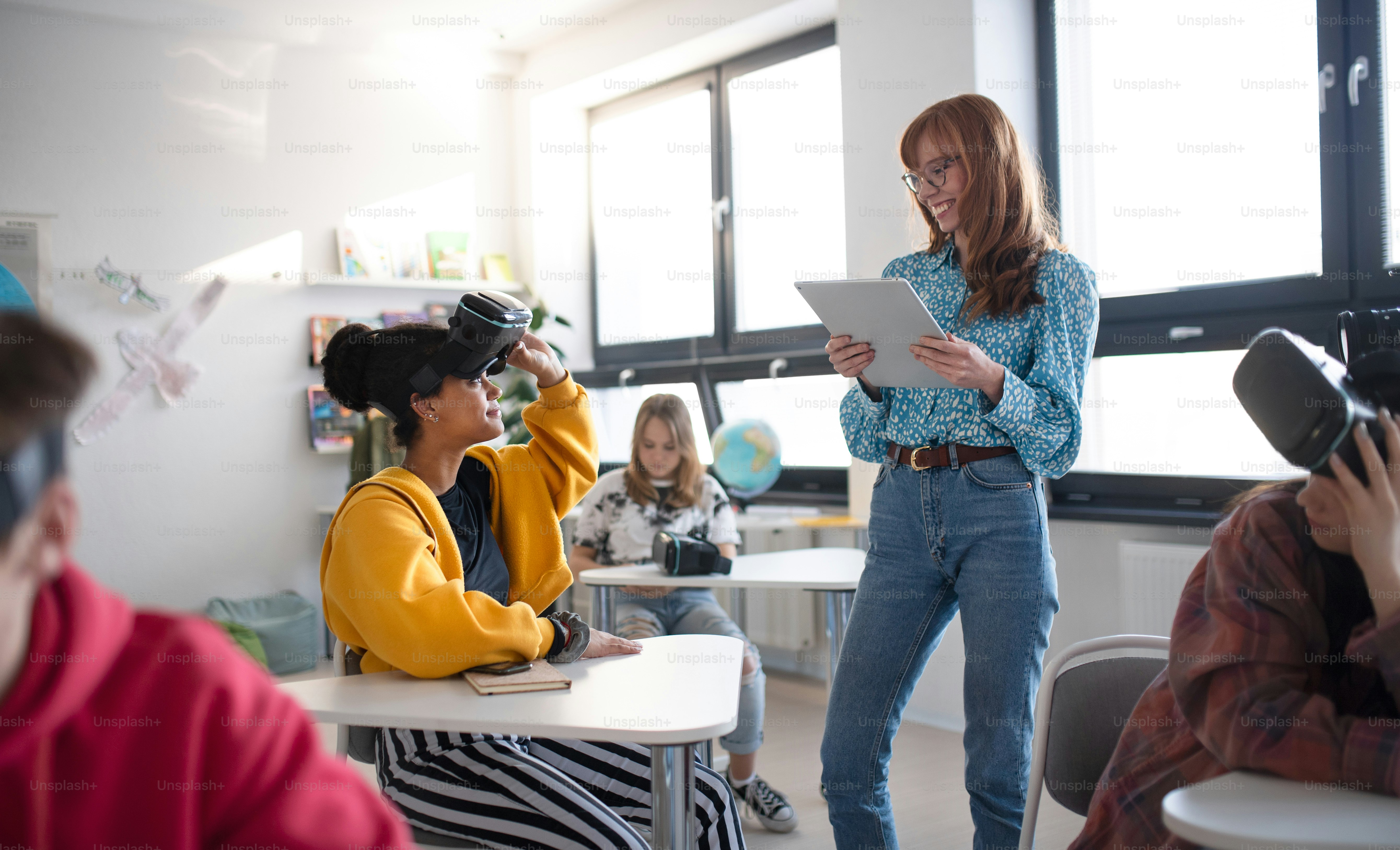 Happy young High school teacher giving lesson to students with VR ...