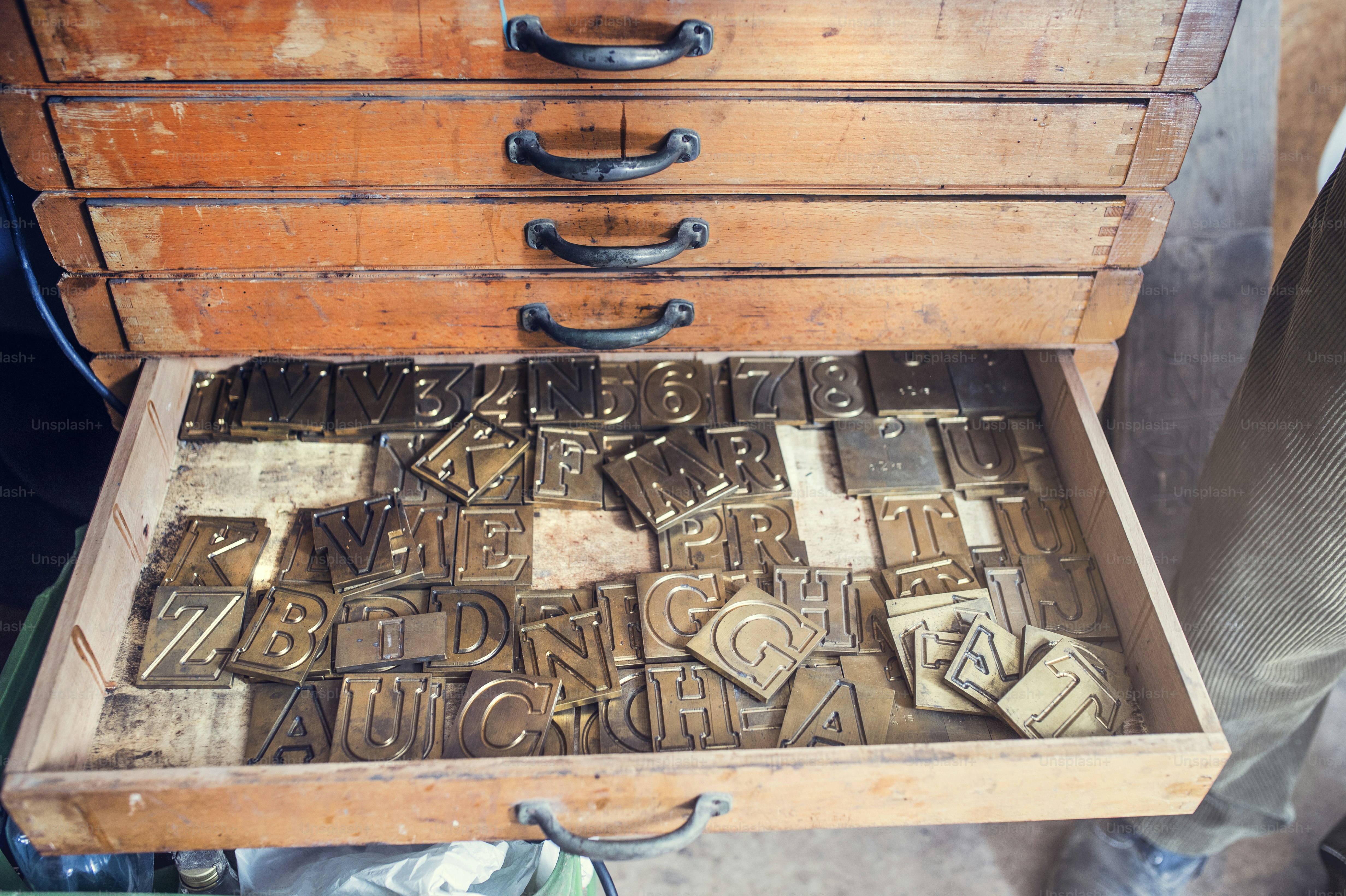 Letters for engraving in an old drawer in the workshop of a crafsman ...