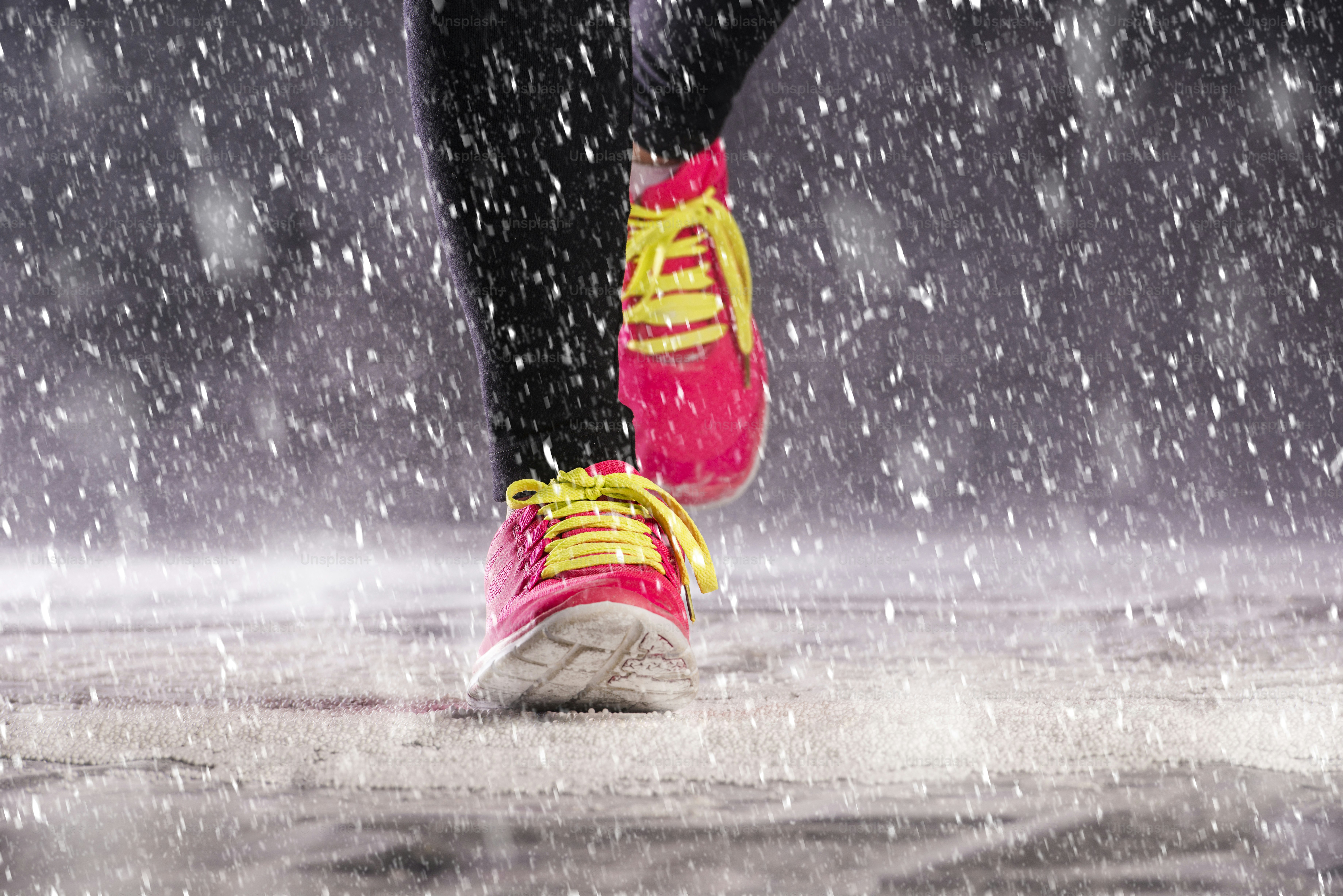 Athlete woman is running during winter training outside in cold snow ...
