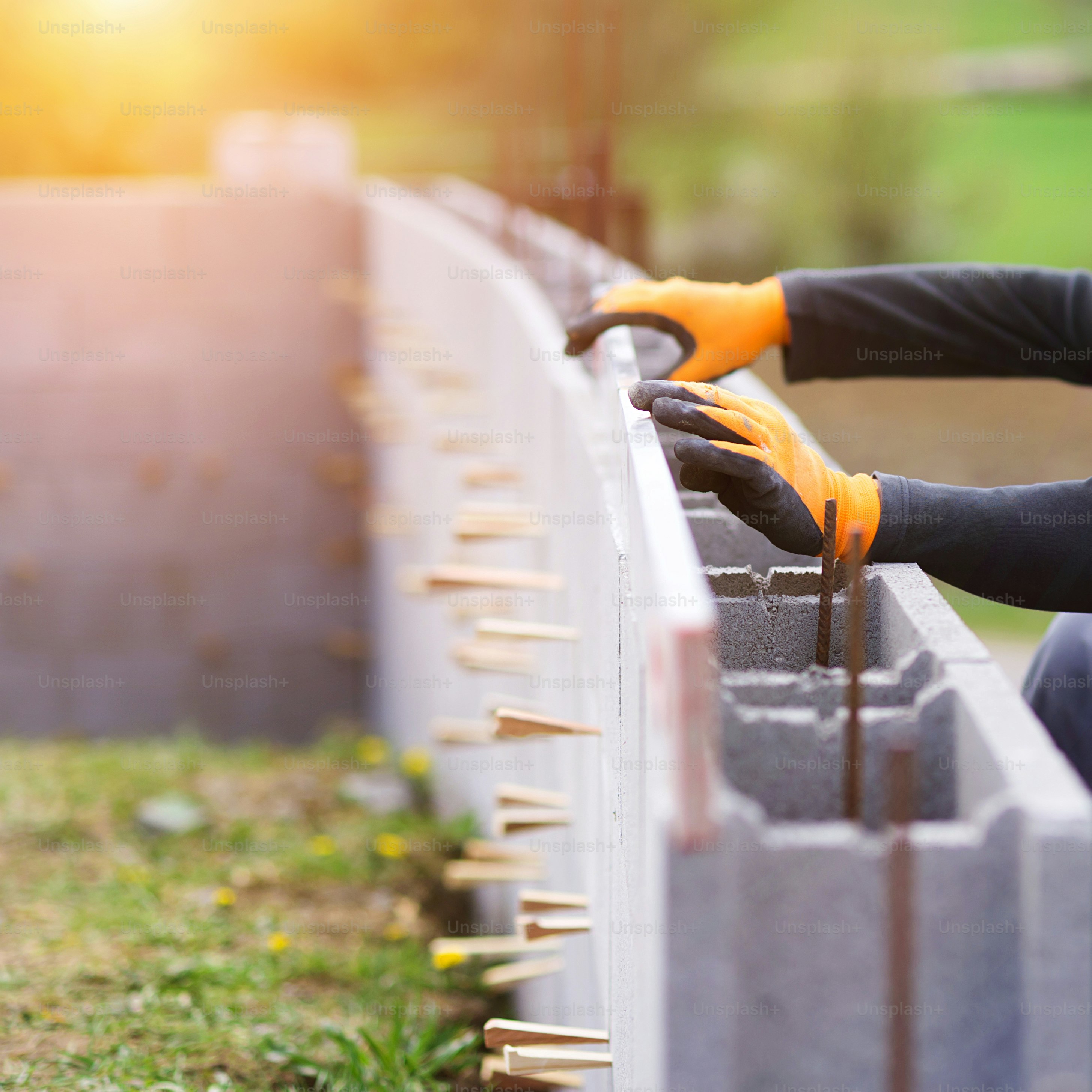 Bricklayer putting down another row of bricks in site photo ...