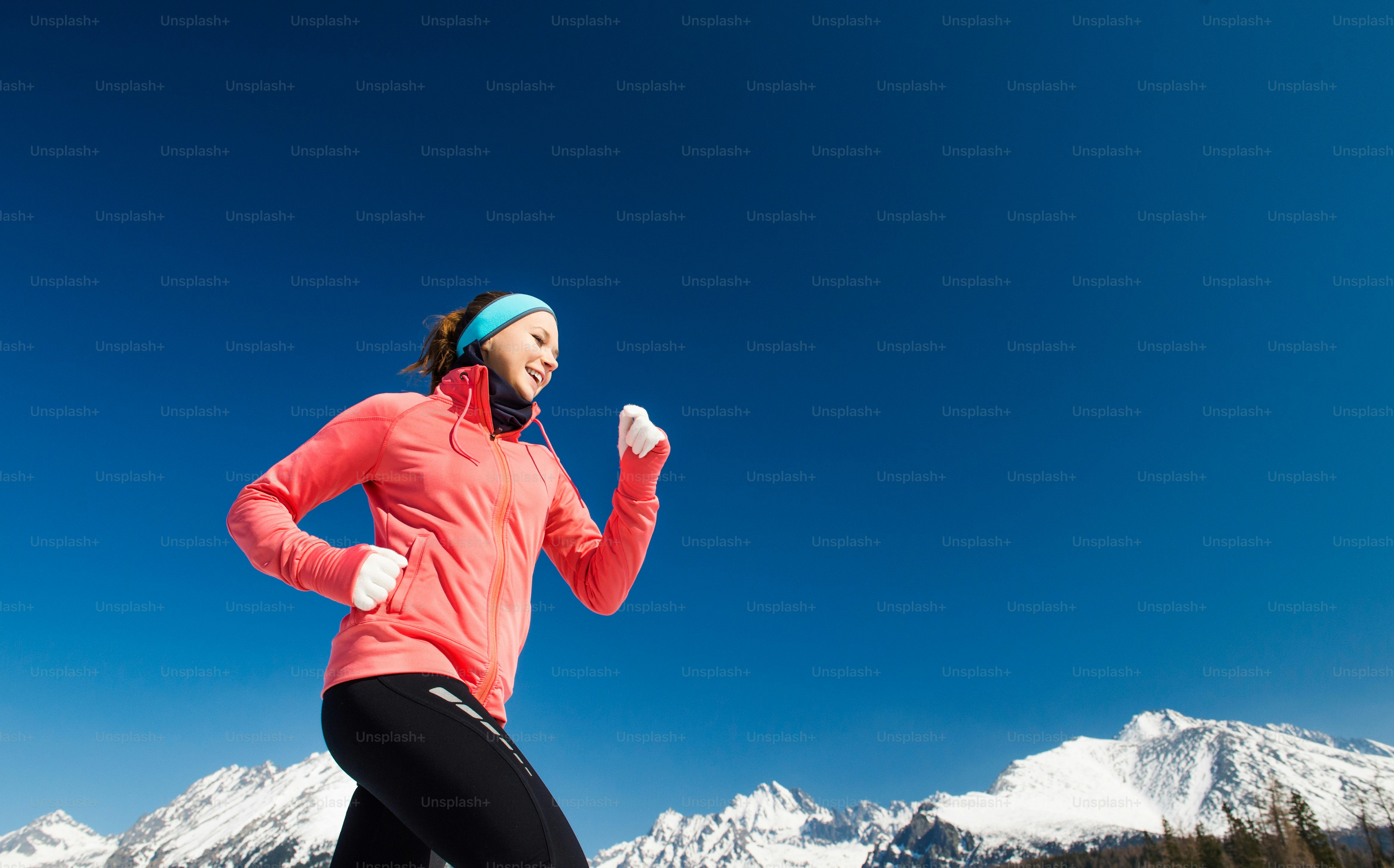 Young woman jogging outside in sunny winter mountains photo – Nature ...