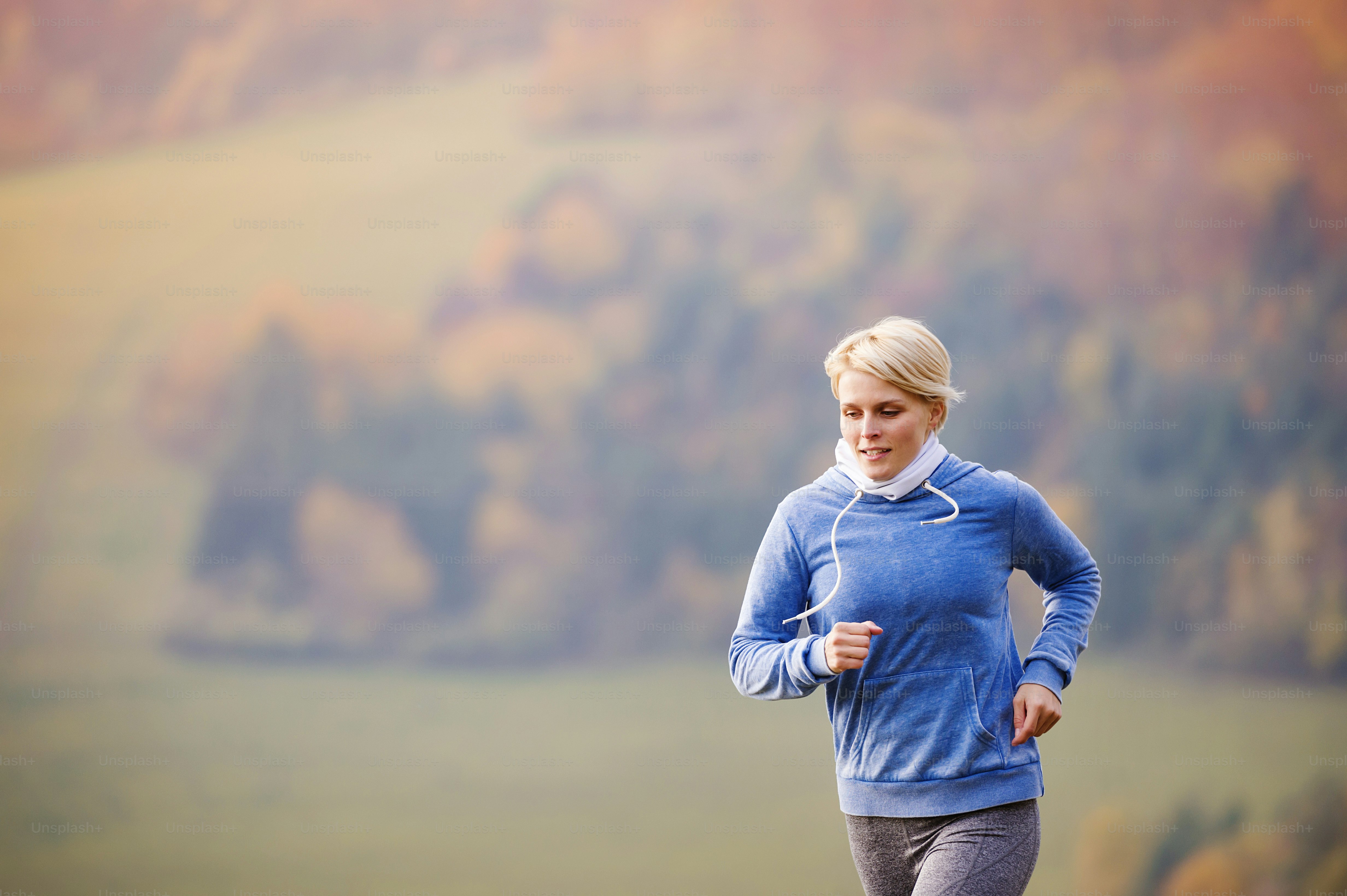 Young woman running outside in sunny nature photo – Exercising Image on ...