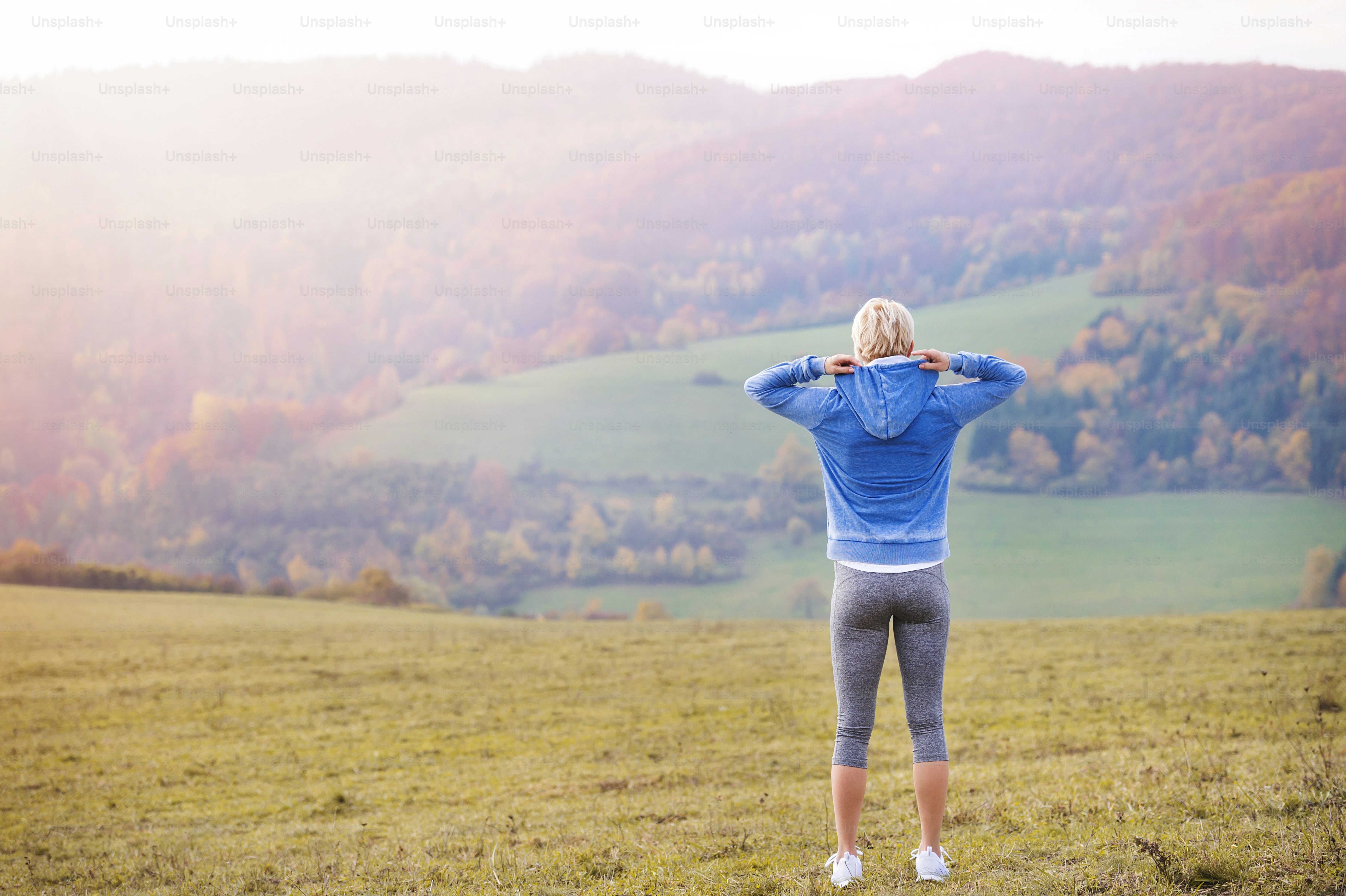 Young woman running outside in autumn nature photo – Stationary Image ...