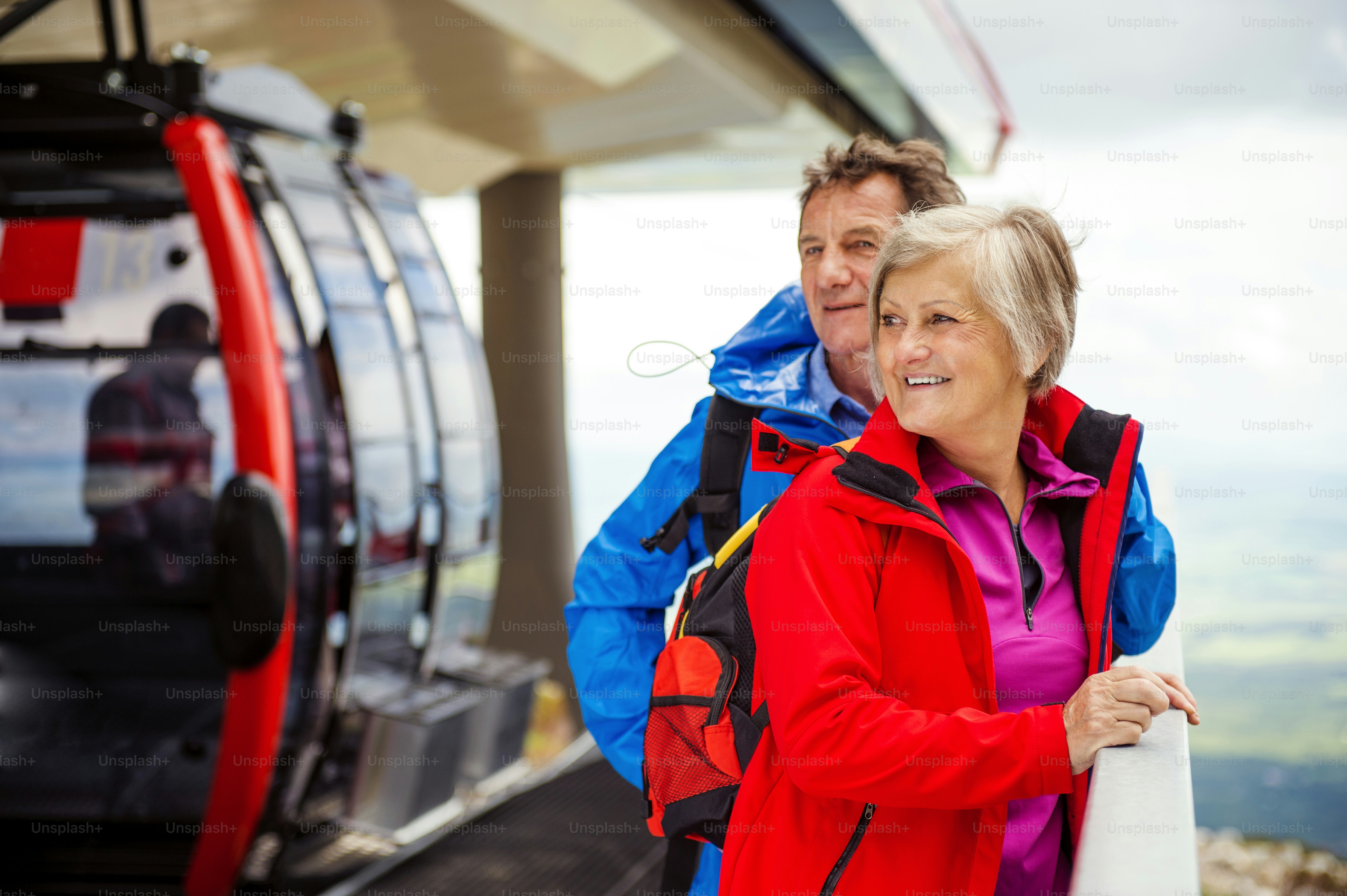 Senior hikers couple is waiting for cableway in cable station photo ...