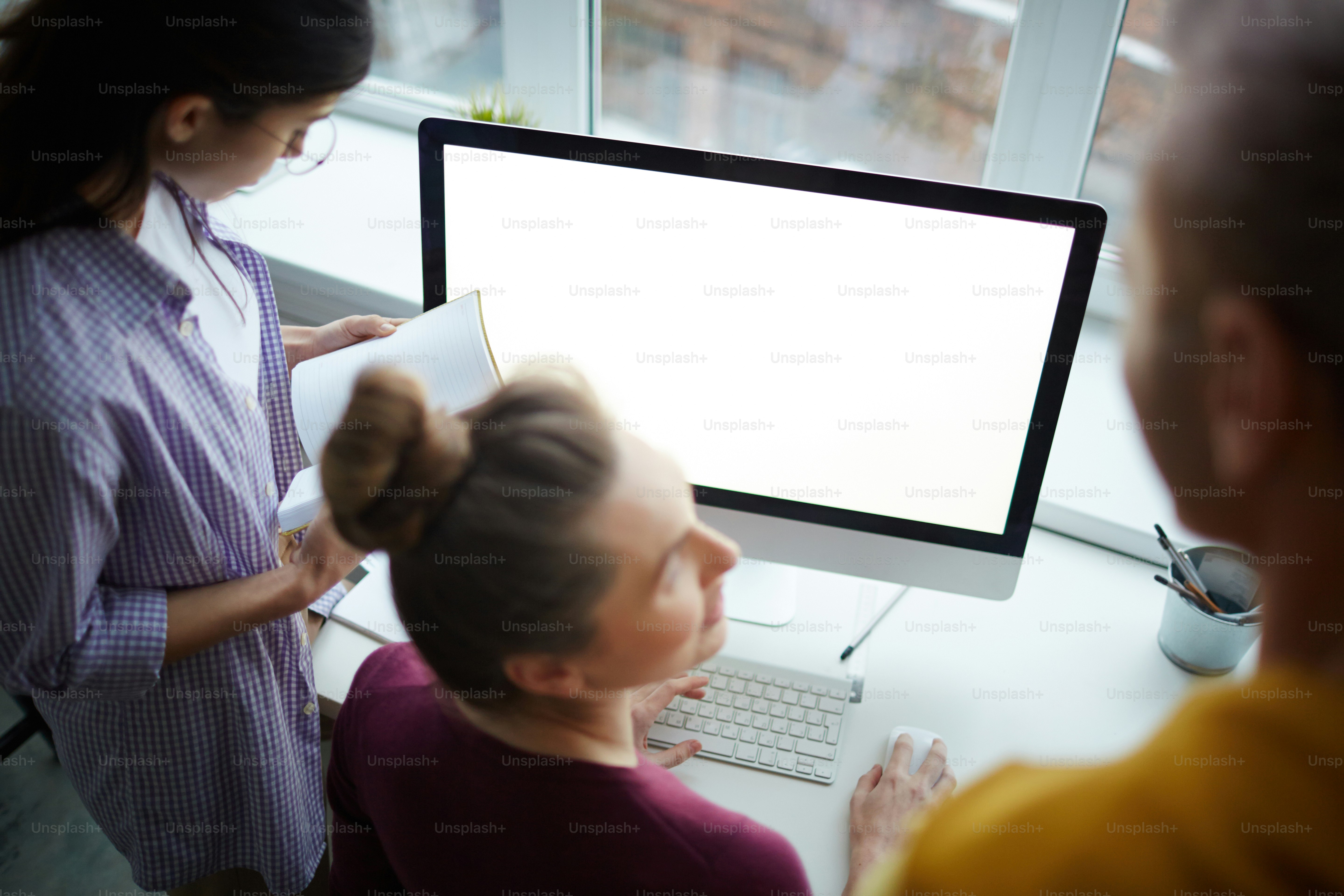 Portrait of creative team working at agency. They discussing project on ...
