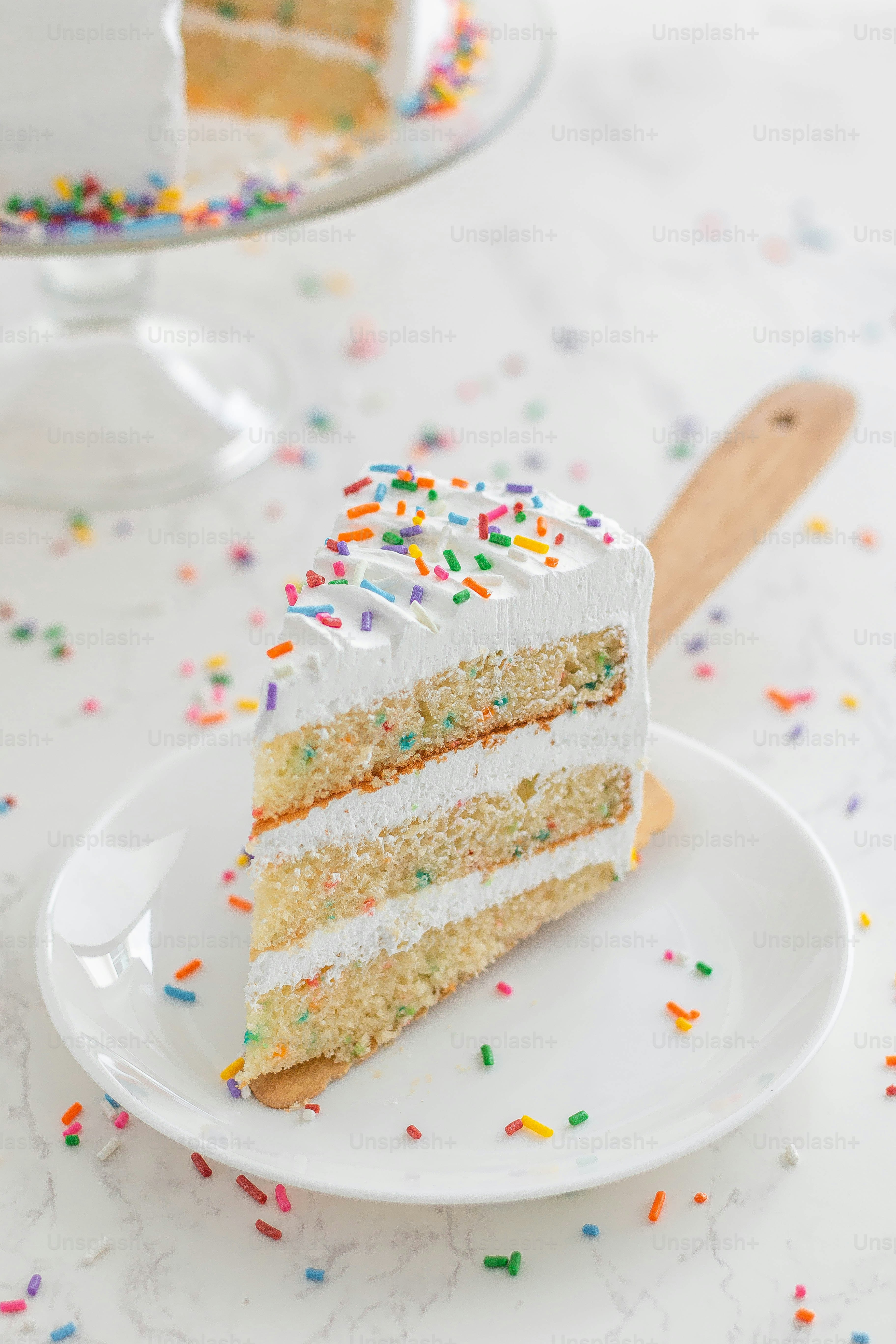 A slice of cake on a plate with sprinkles photo – Cake Image on Unsplash