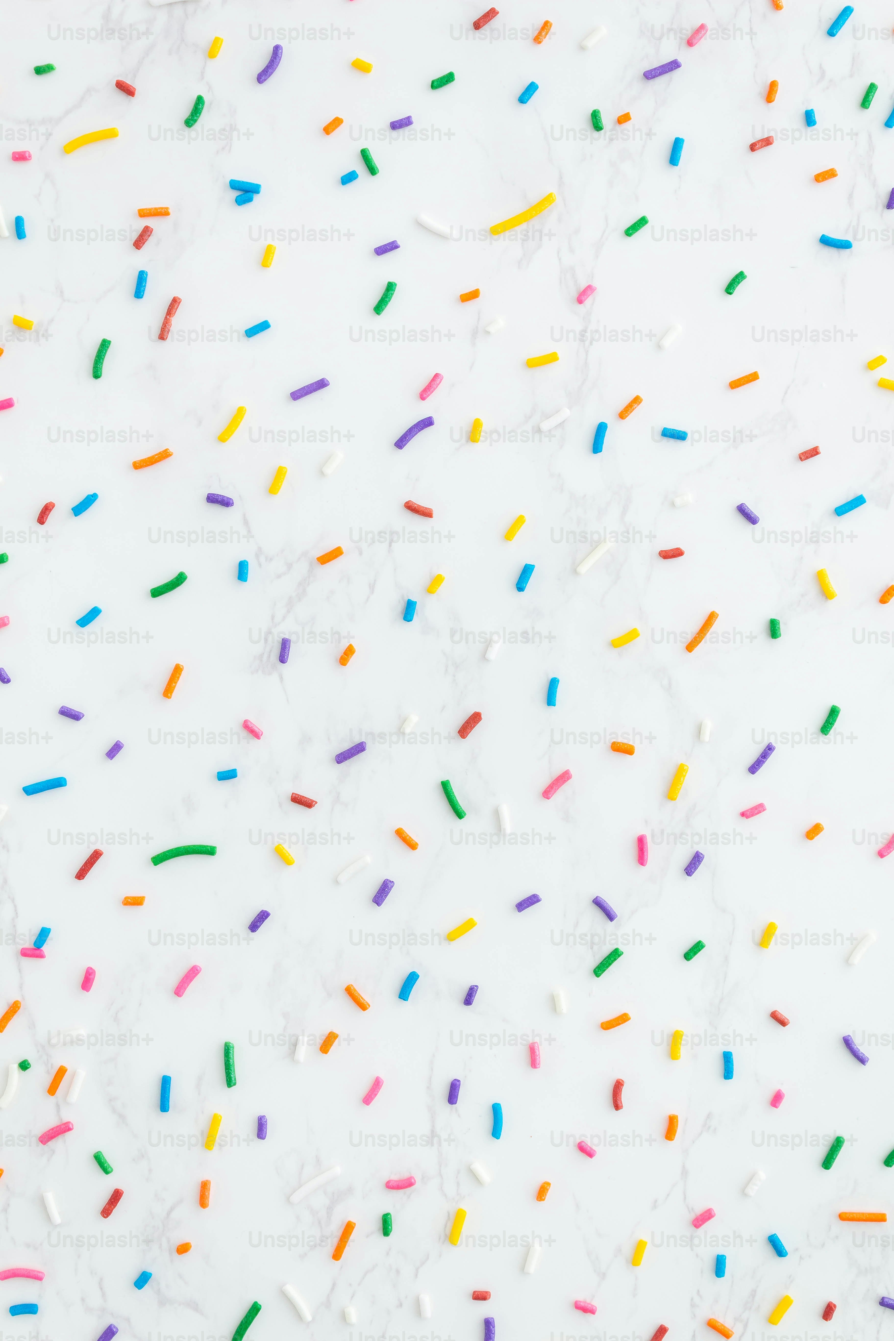 Sprinkles on a white surface with a white background photo – Sprinkle ...