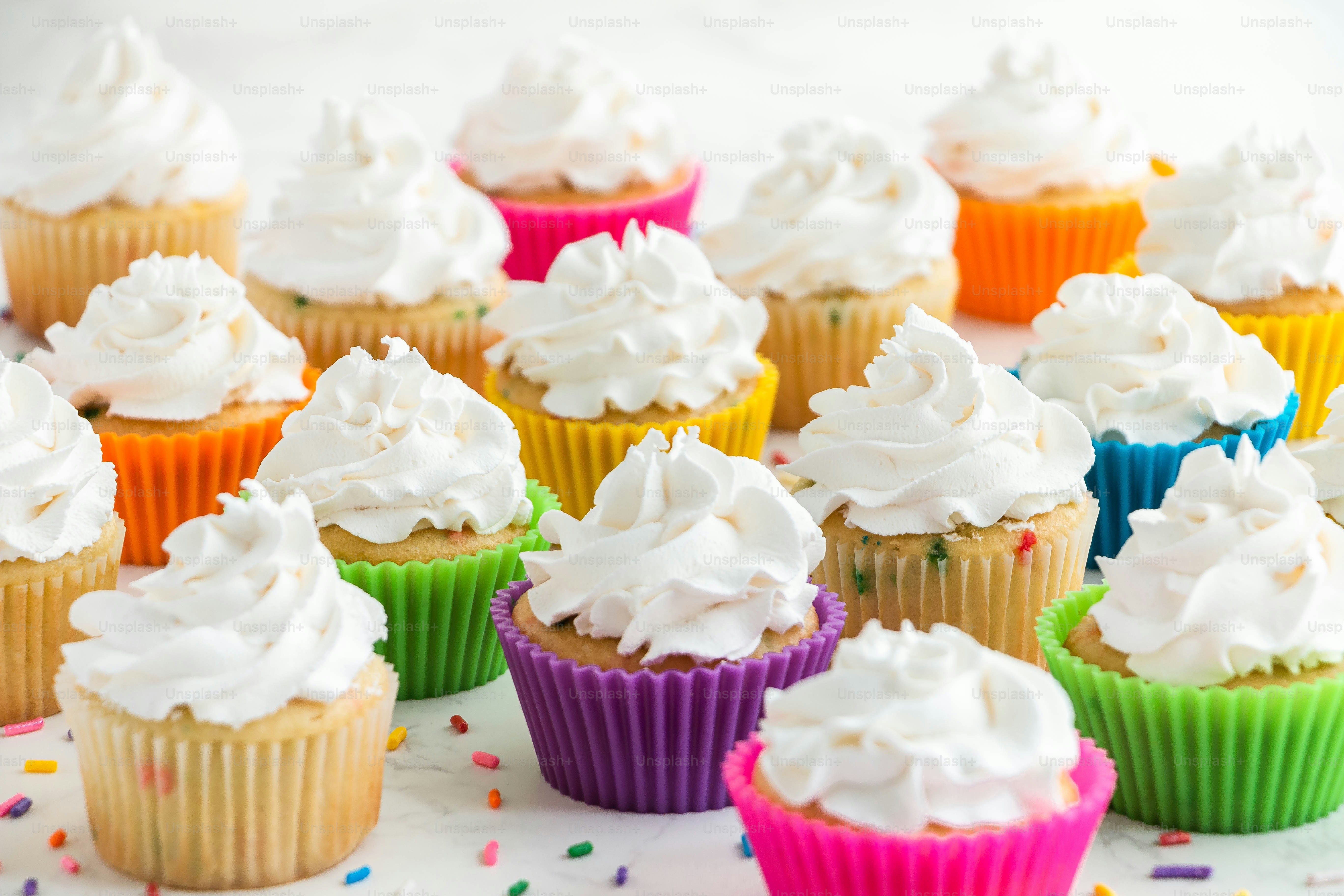A bunch of cupcakes with white frosting and sprinkles photo – Cake ...