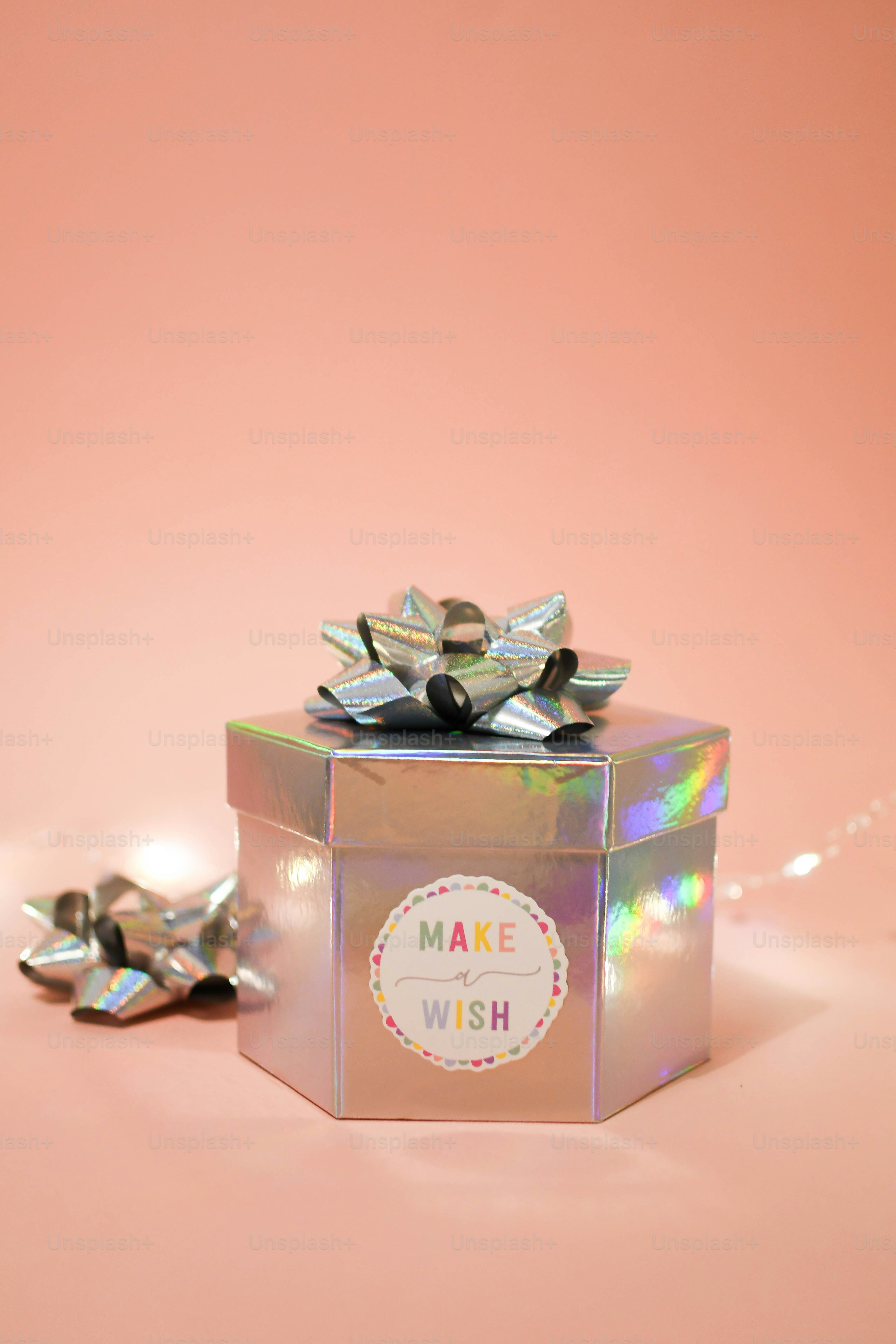 A small box with a bow on top of it photo – Celebrations Image on Unsplash