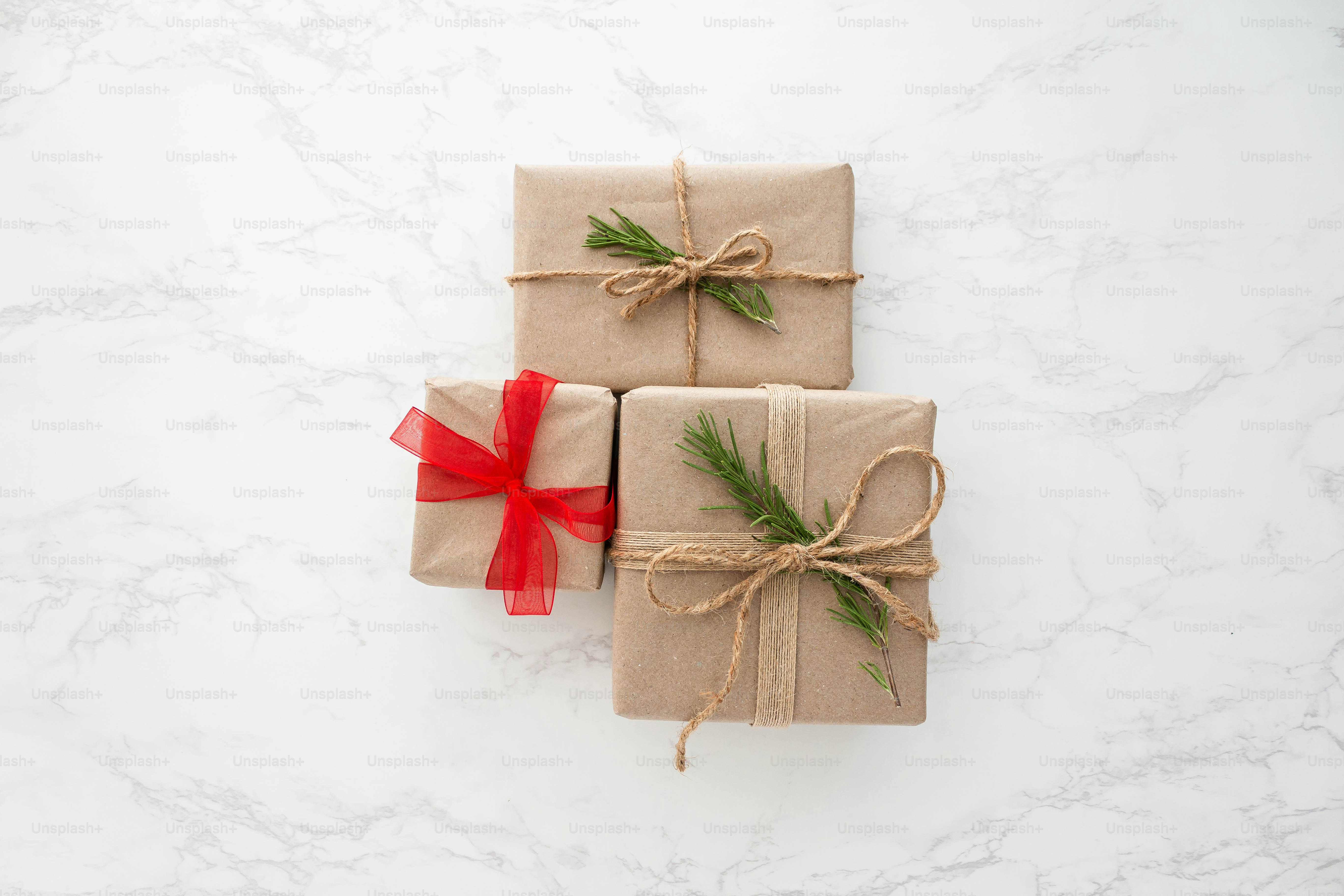 A couple of wrapped presents sitting on top of a table photo – Holidays ...