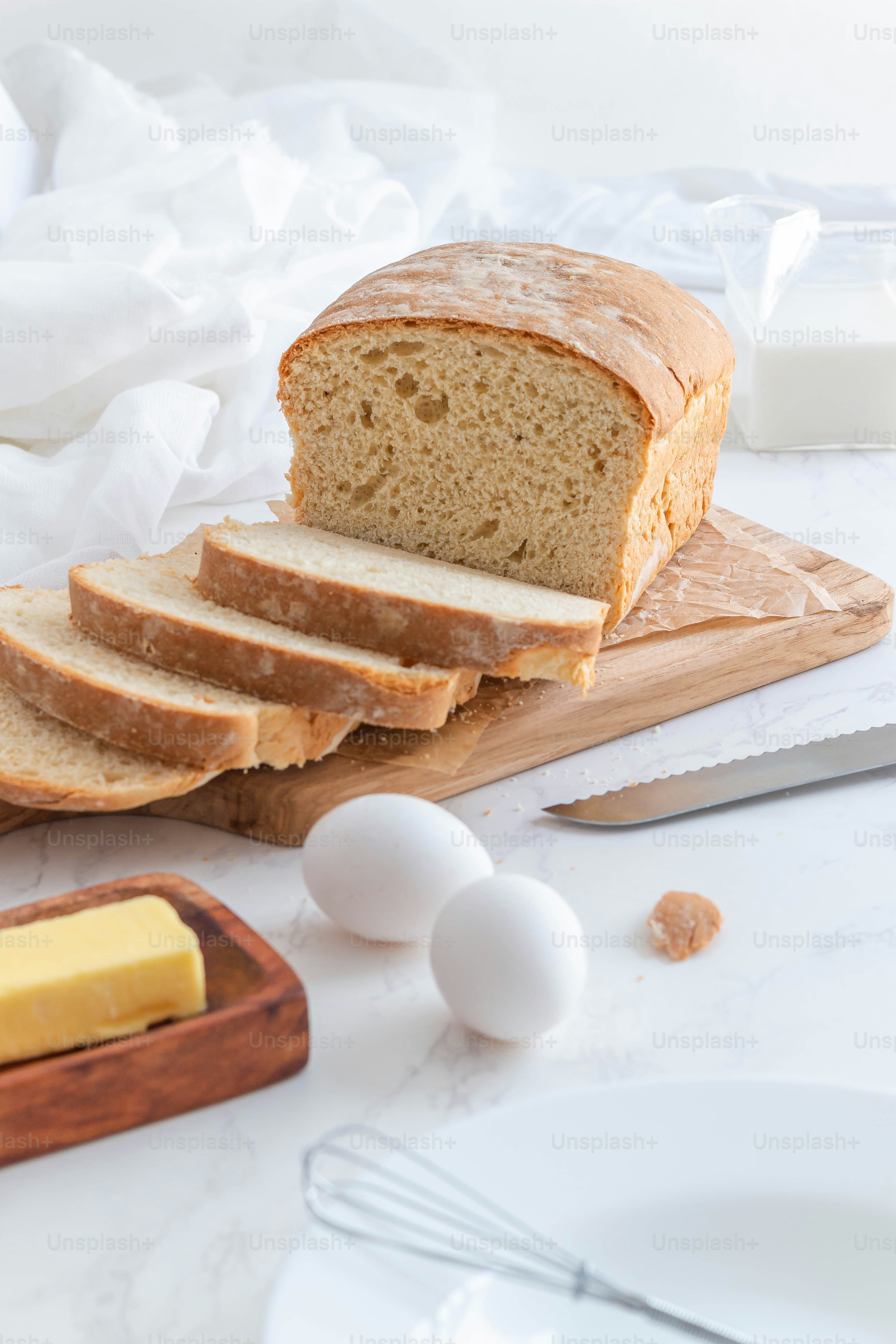 A loaf of bread sitting on top of a cutting board photo – Food Image on ...
