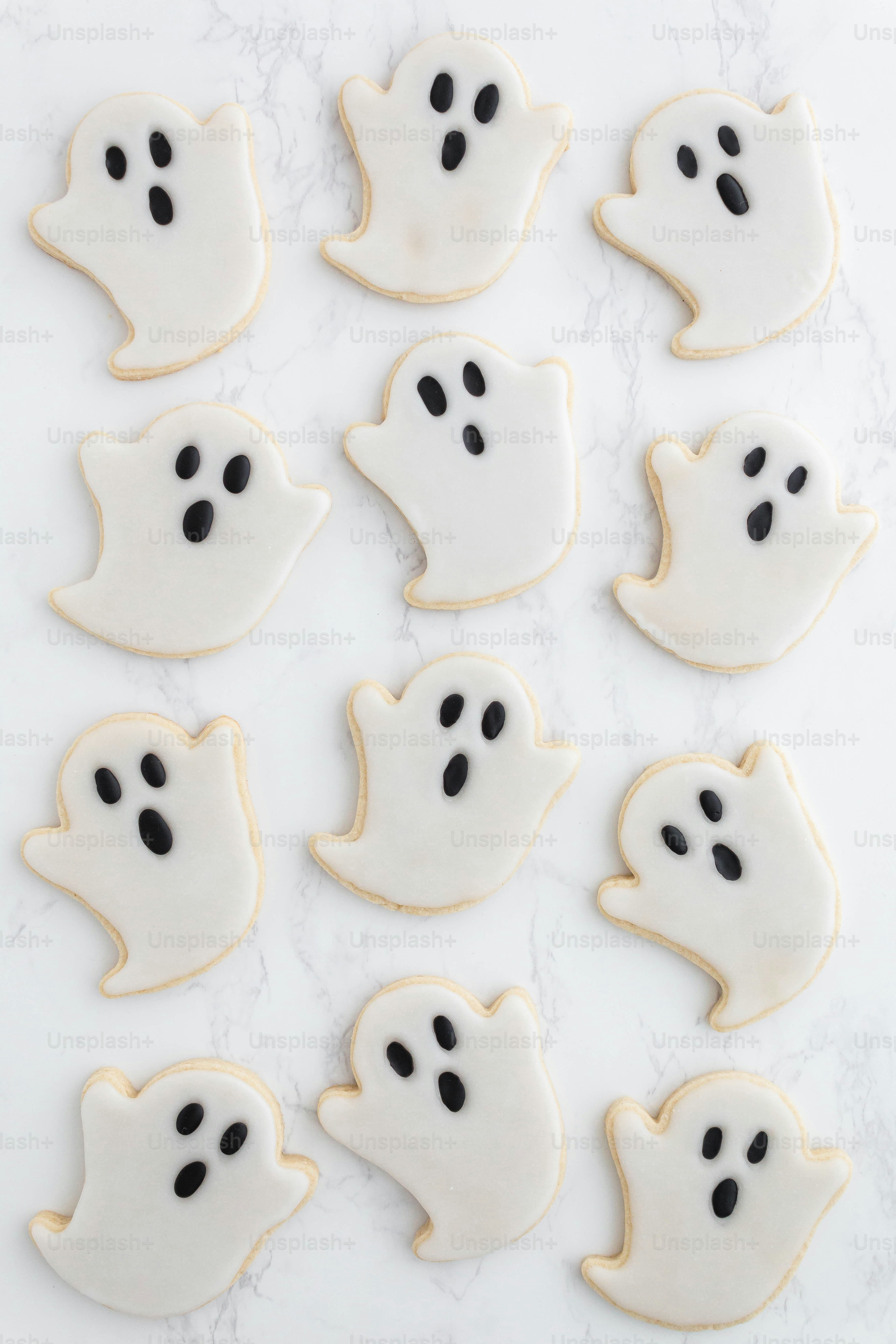 A bunch of cookies that have been decorated to look like ghost faces photo – Halloween ...