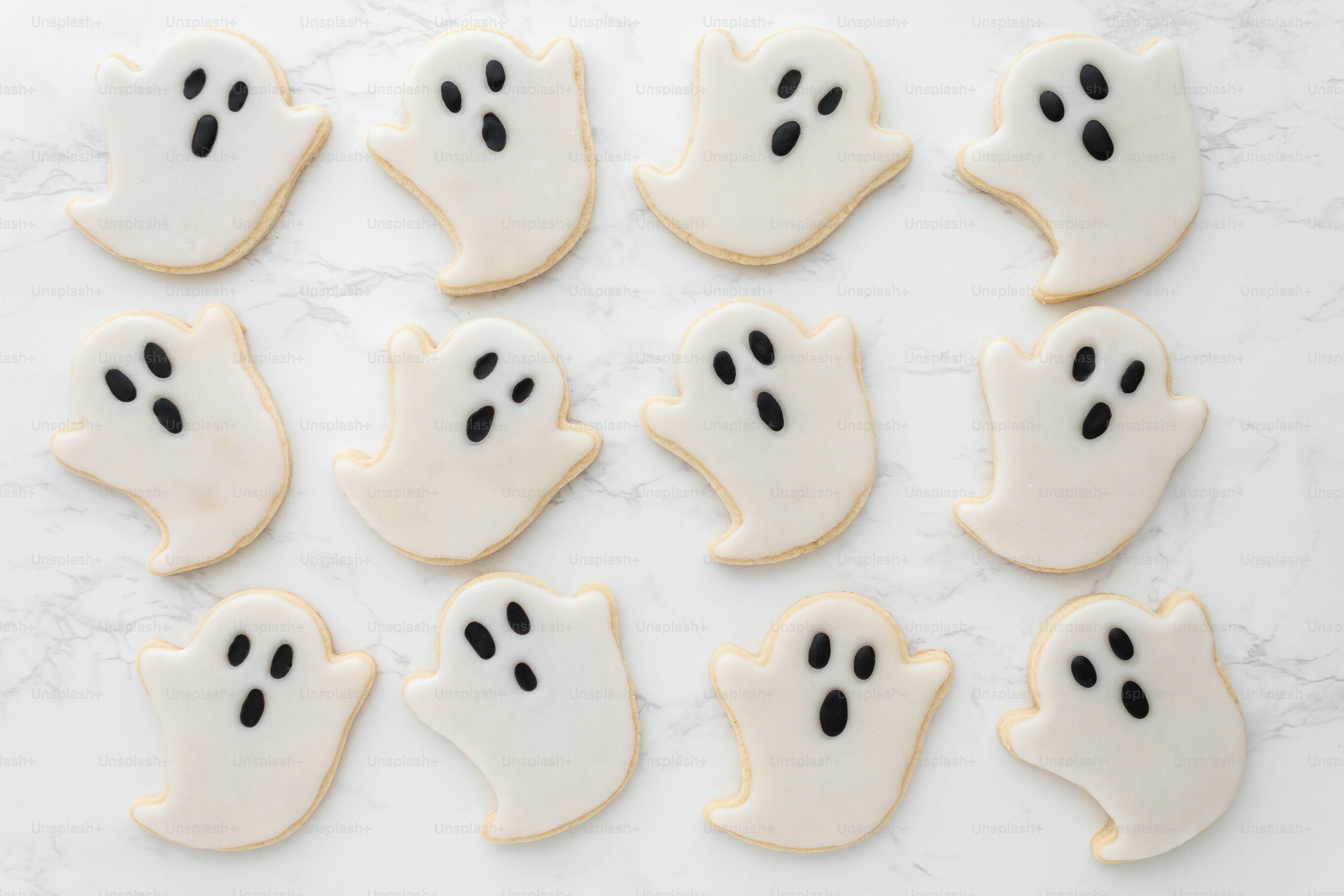 A bunch of cookies that have been decorated to look like ghost faces photo – Halloween ...