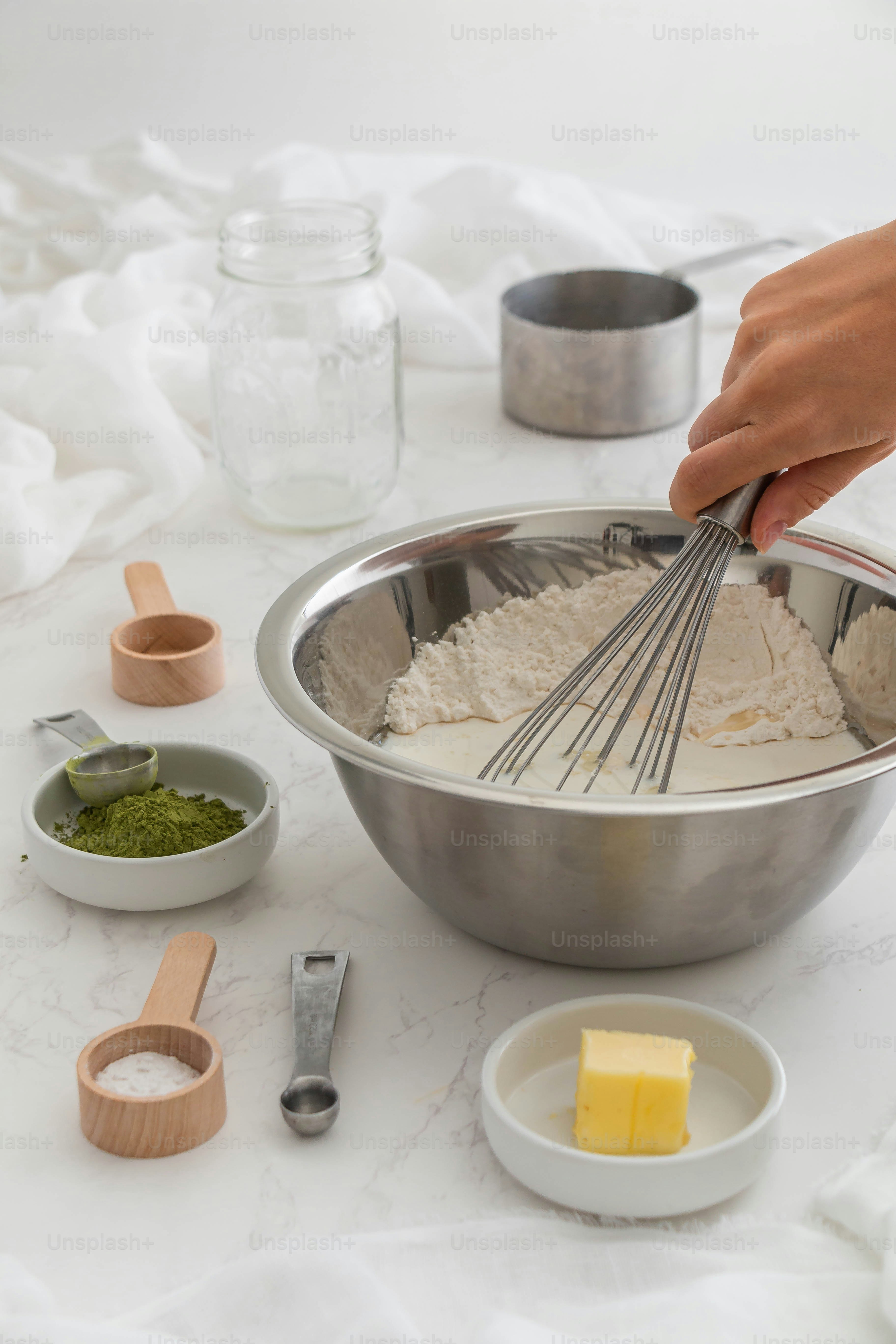A person mixing ingredients in a mixing bowl photo – Mixing Image on ...
