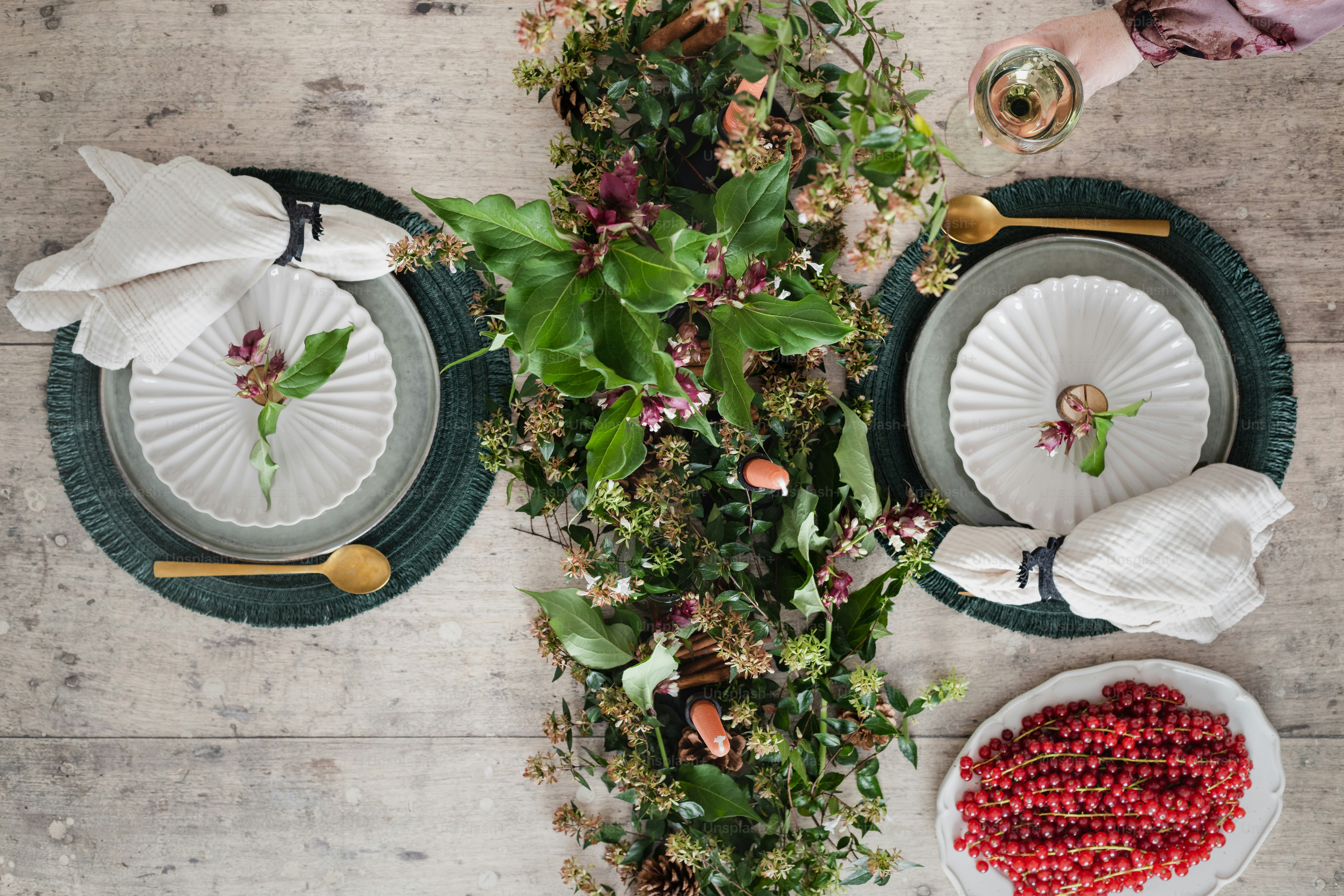 A table topped with plates and bowls of food photo – Table decorations ...