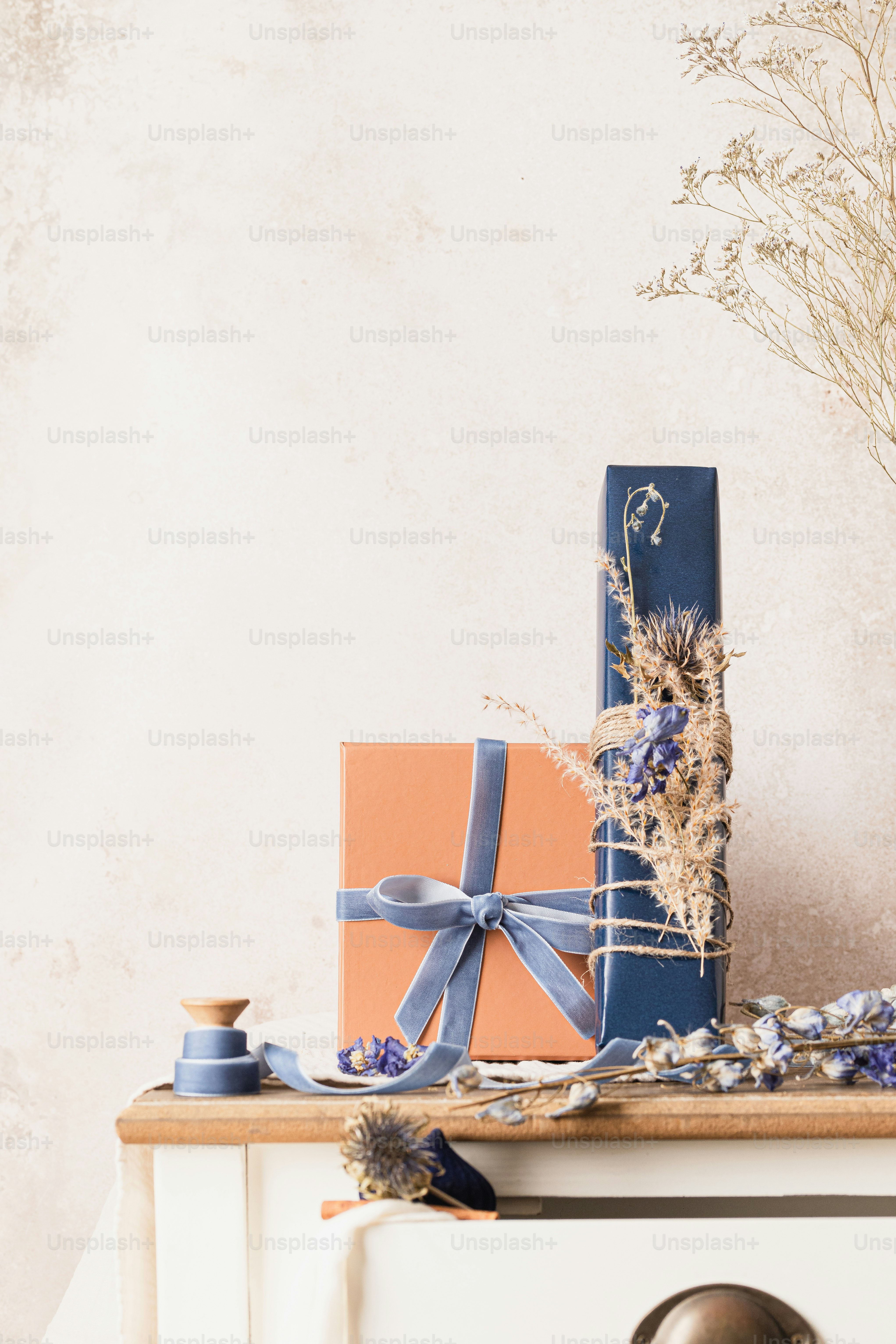 A stack of wrapped presents sitting on top of a table photo – Festive ...