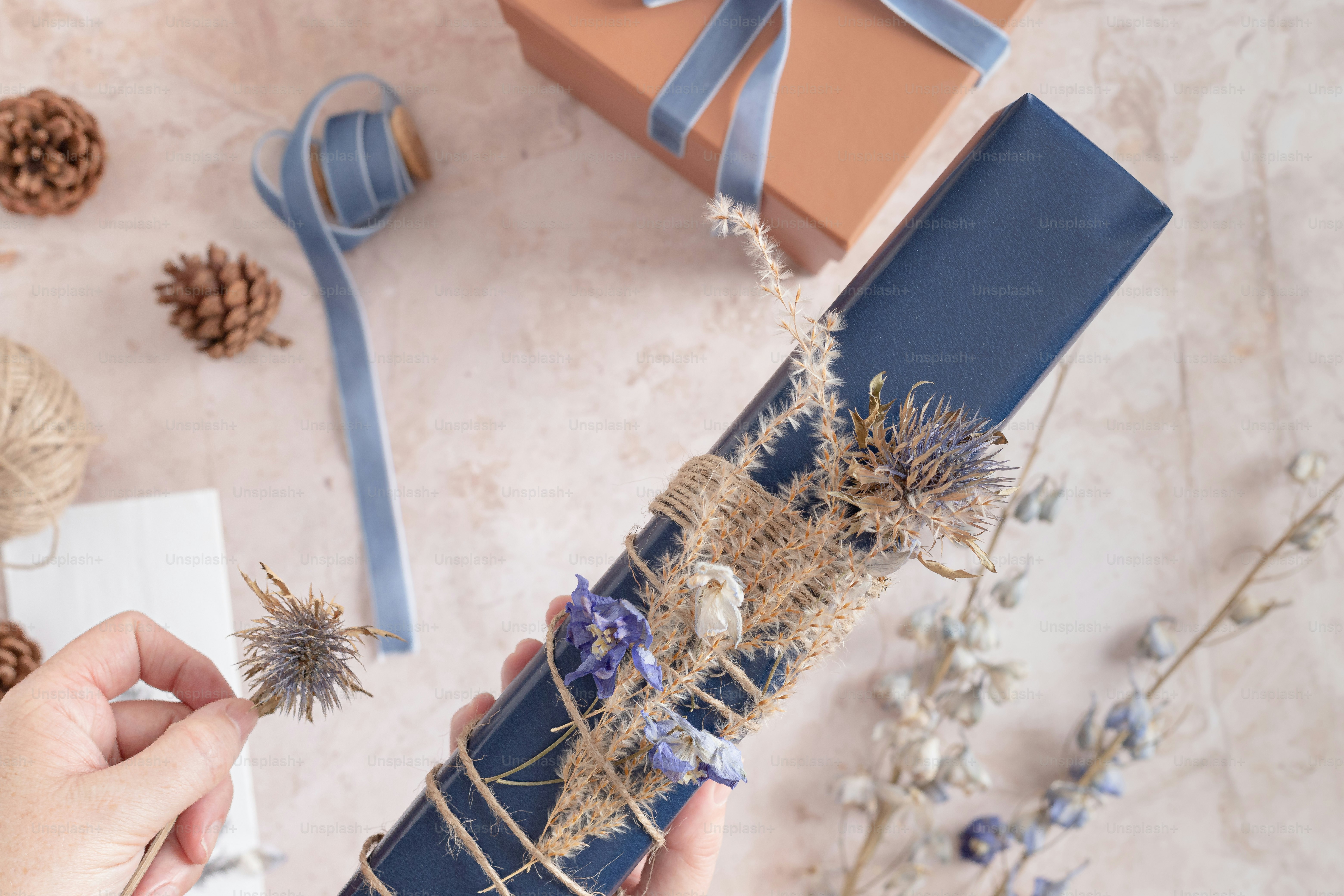 A person holding a blue wrapped gift in their hand photo – Presents ...