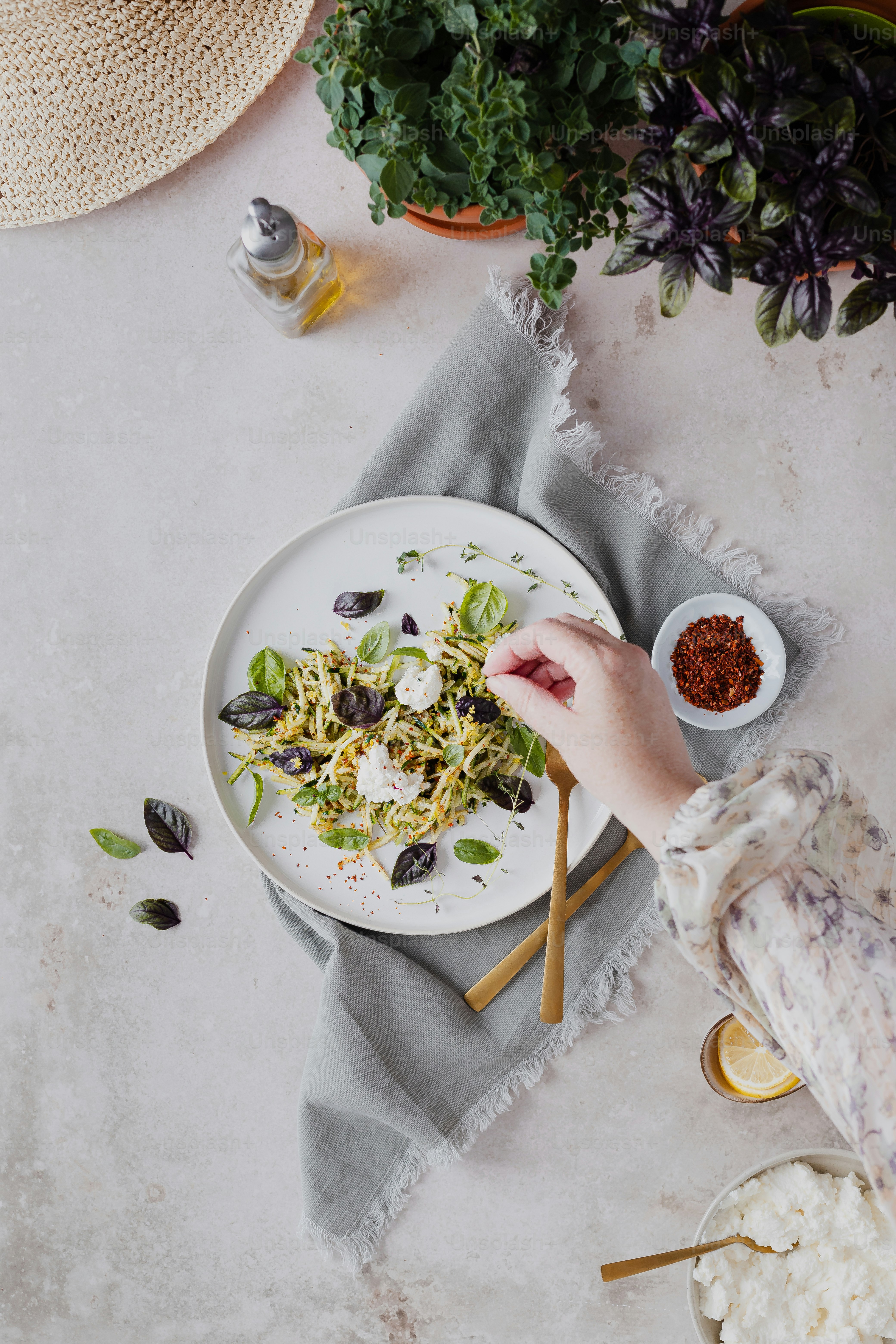 A person reaching for a plate of food on a table photo – Vegetables ...