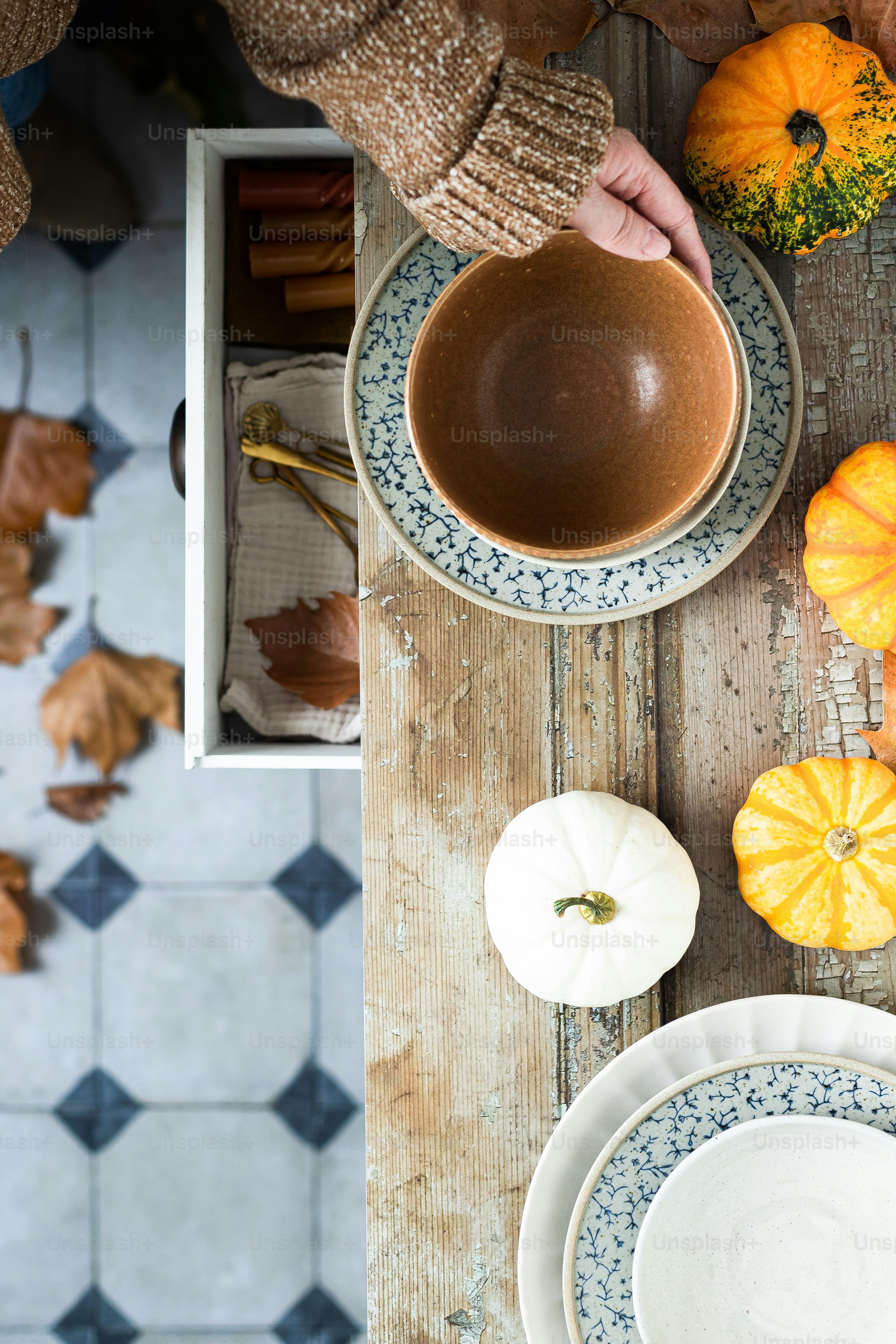 A wooden table topped with plates and bowls photo – Empty plate Image ...